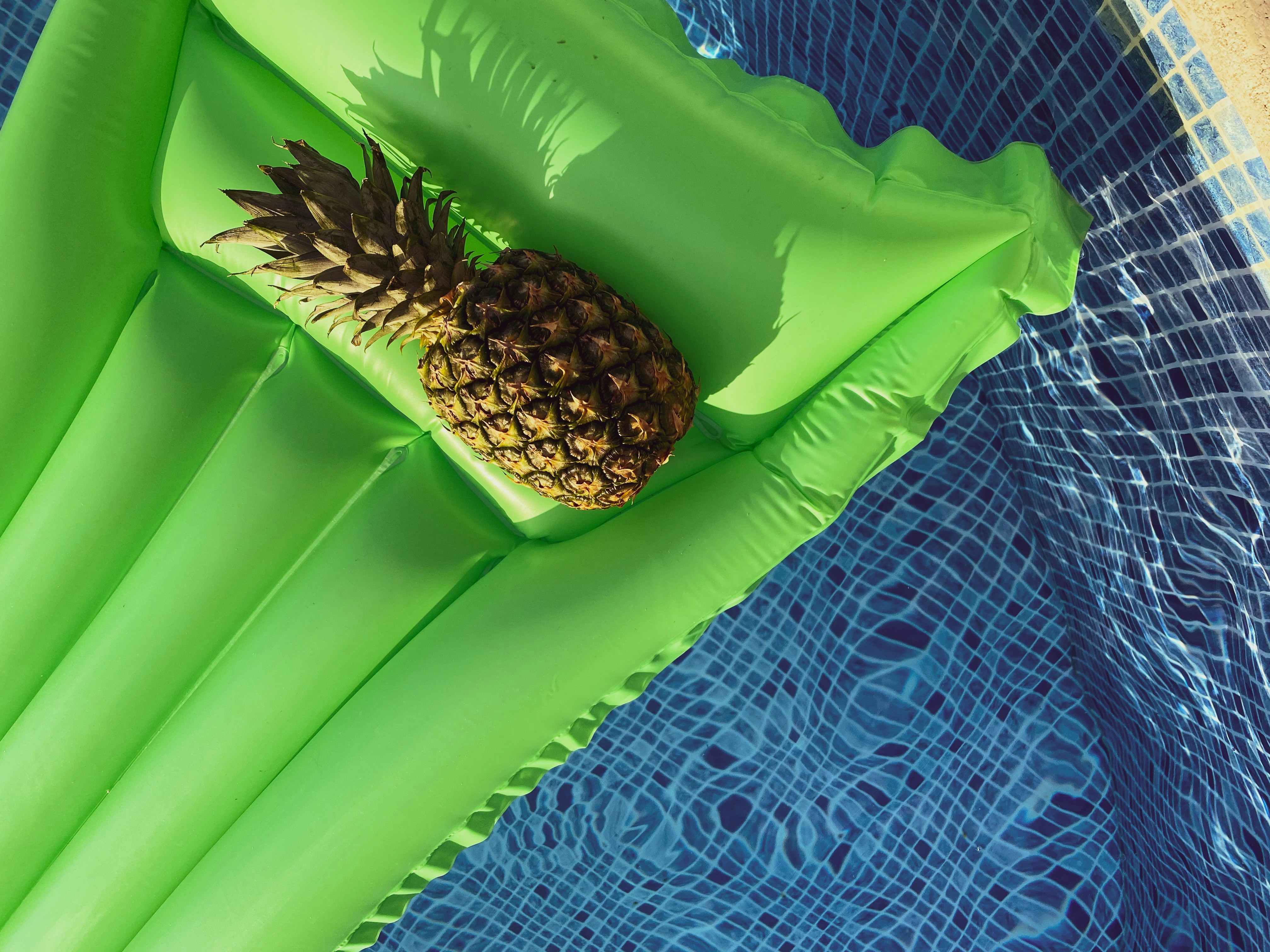 brown and black pineapple on green plastic bag