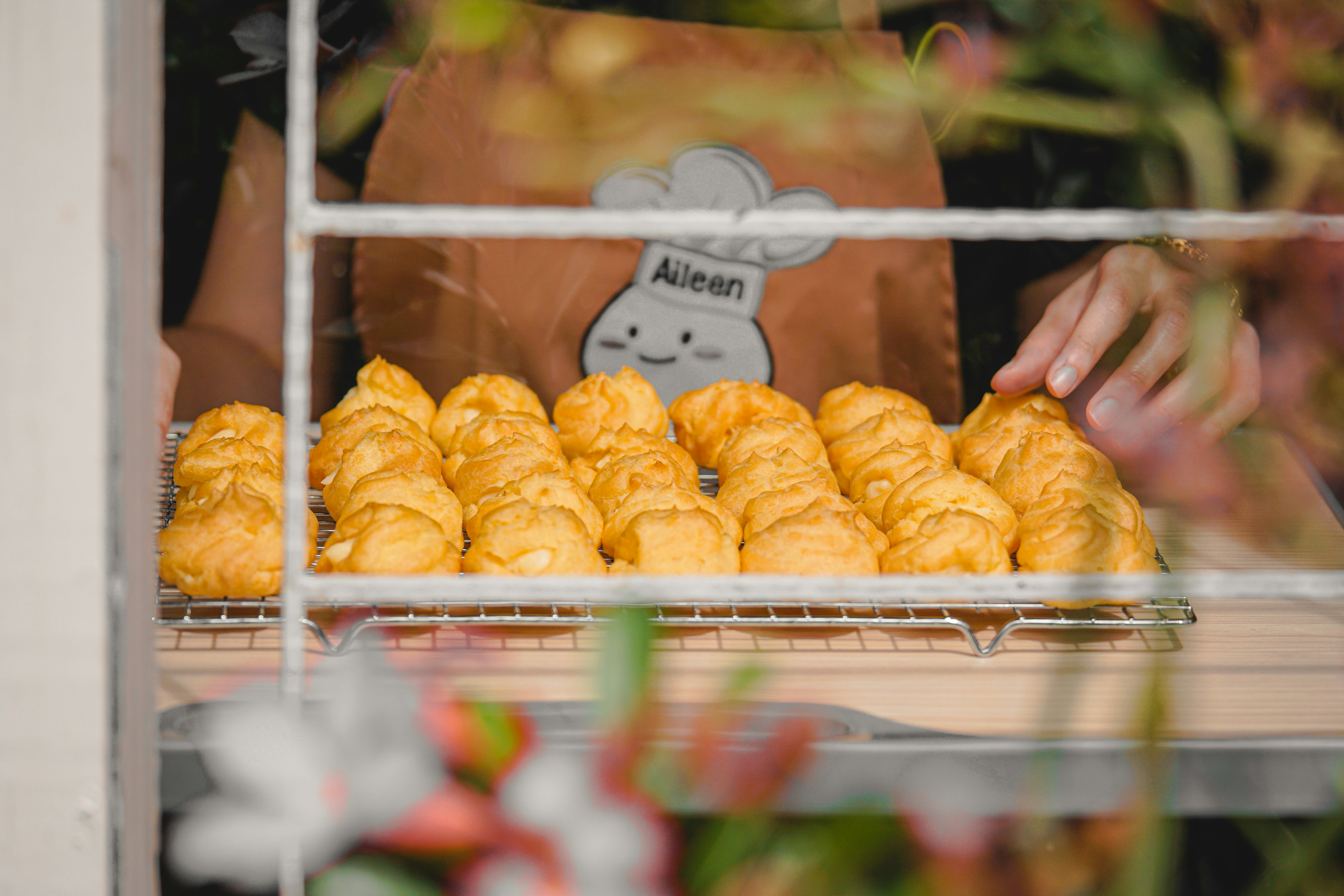 Row of morning croissants: warm crescents glow in a bakery display