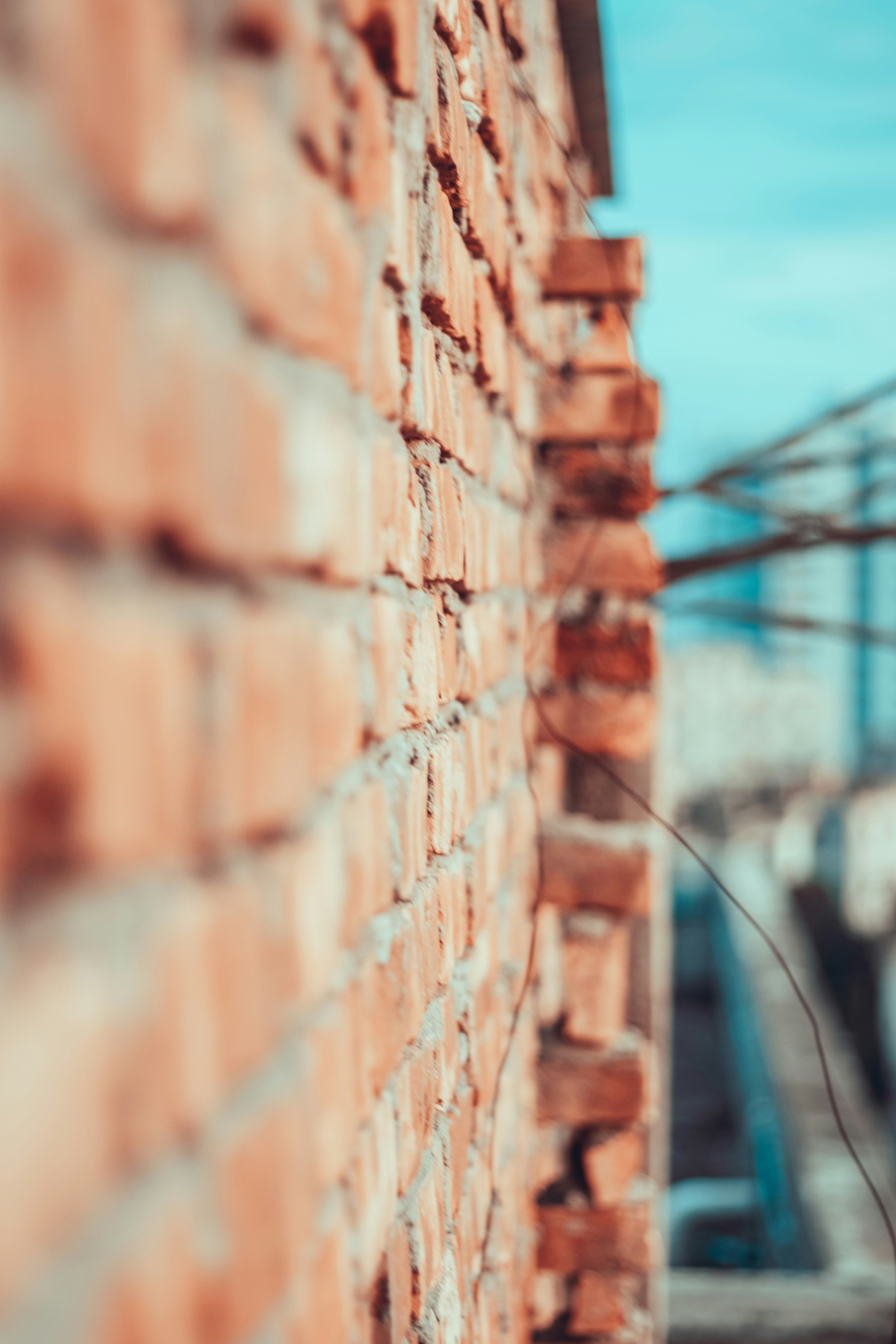 Brick Edge in Focus: Urban Texture Framed by a Distant Skyline