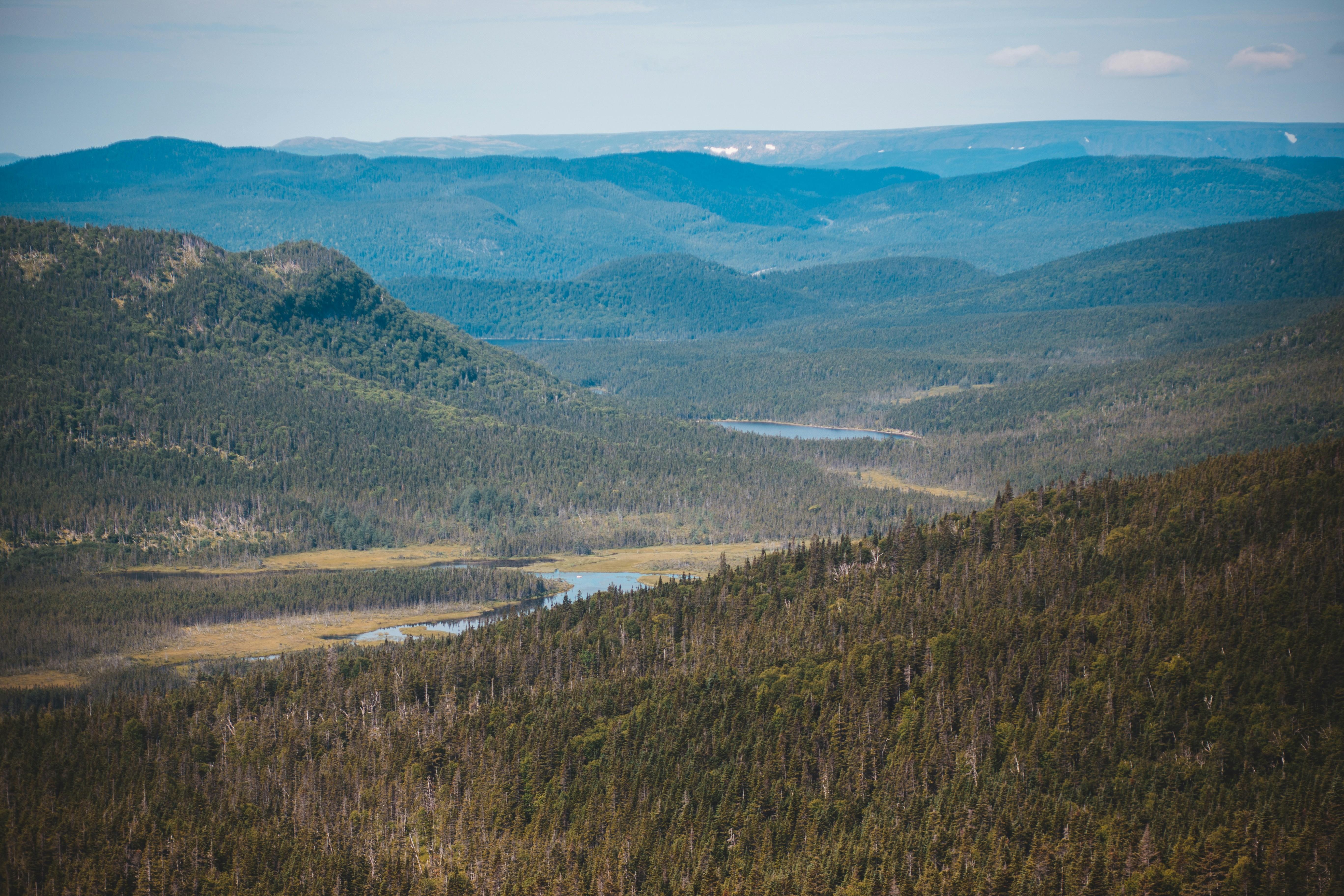 Green and brown grass field near mountain under blue sky during daytime ...