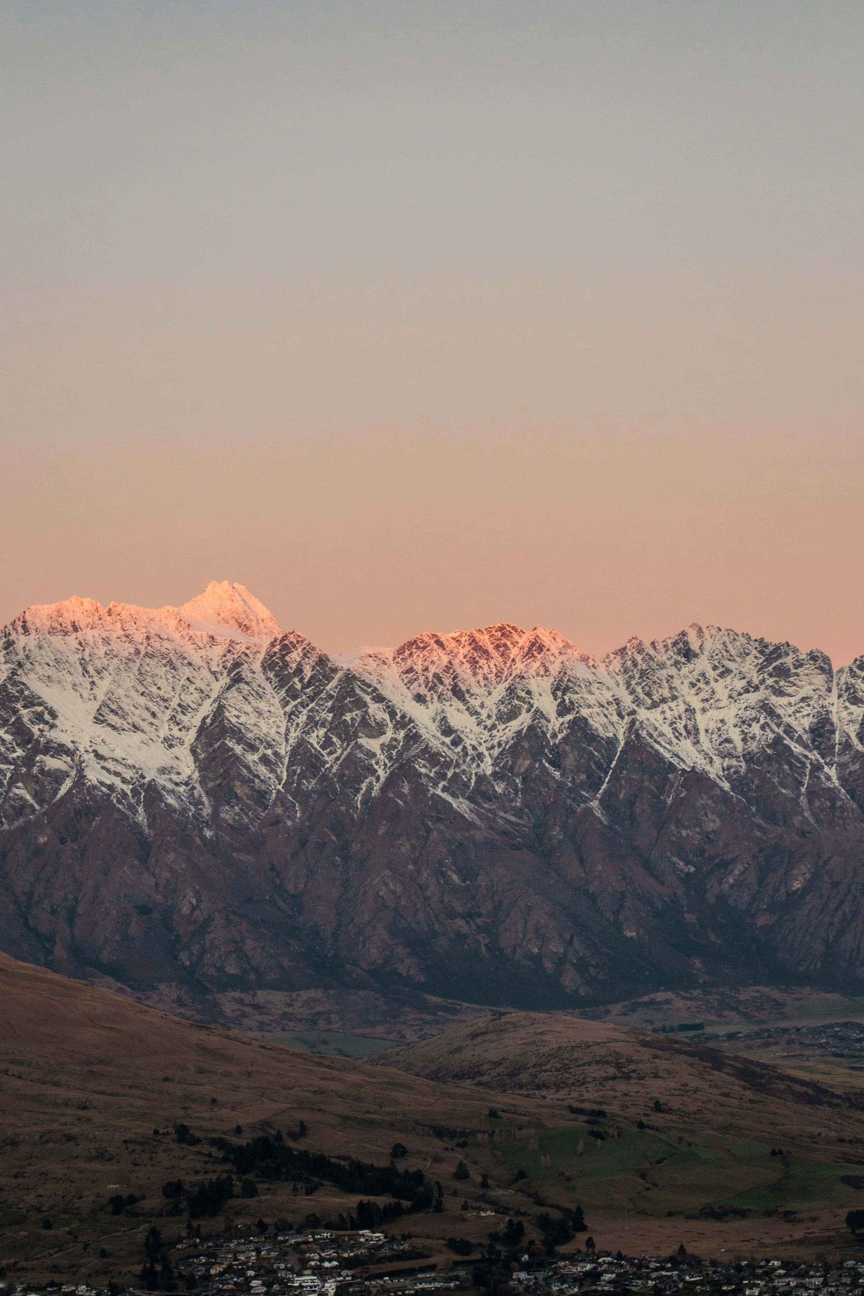 mountains at sunset with field 