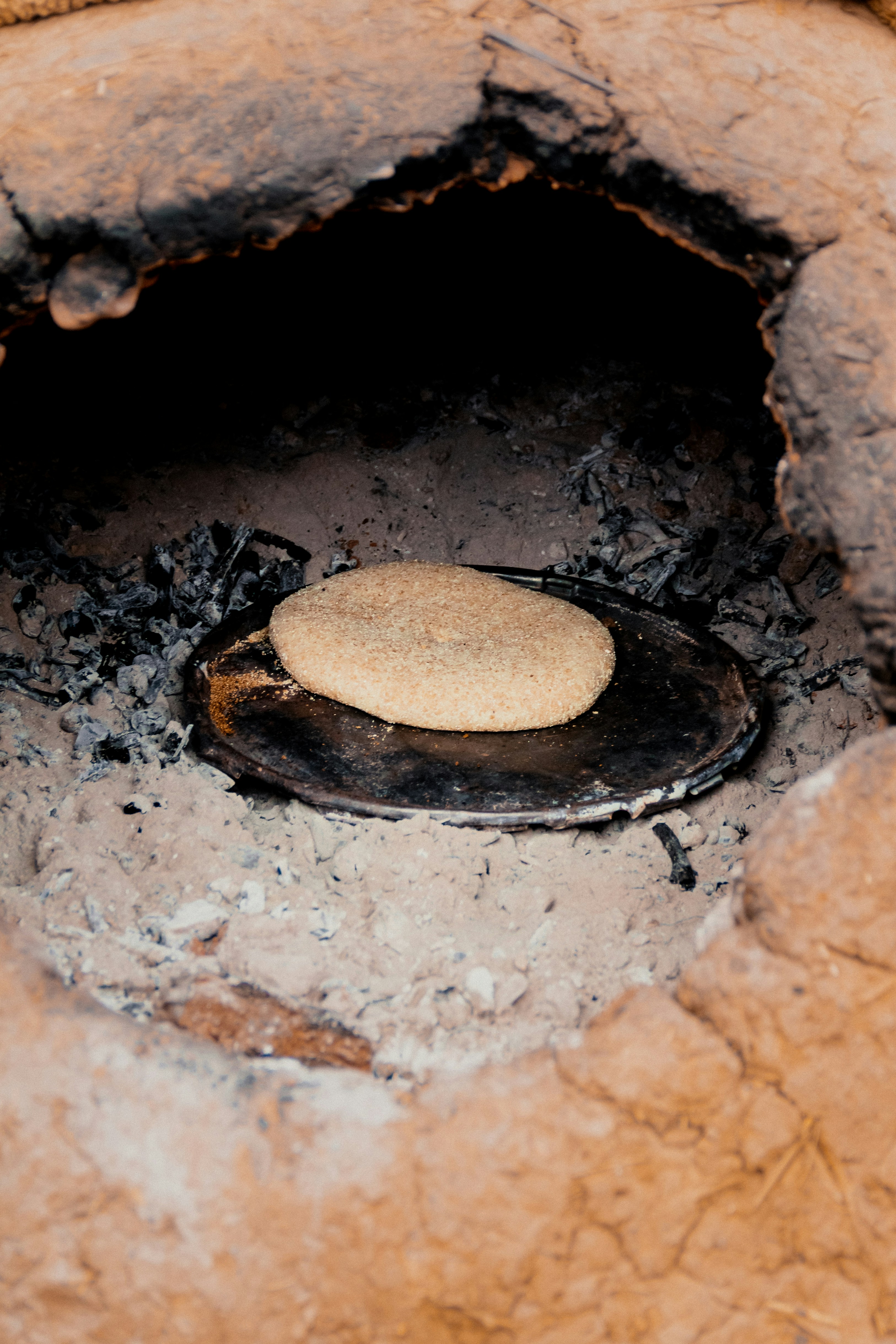 Pancake on a Charred Stone Platform Within a Clay Oven