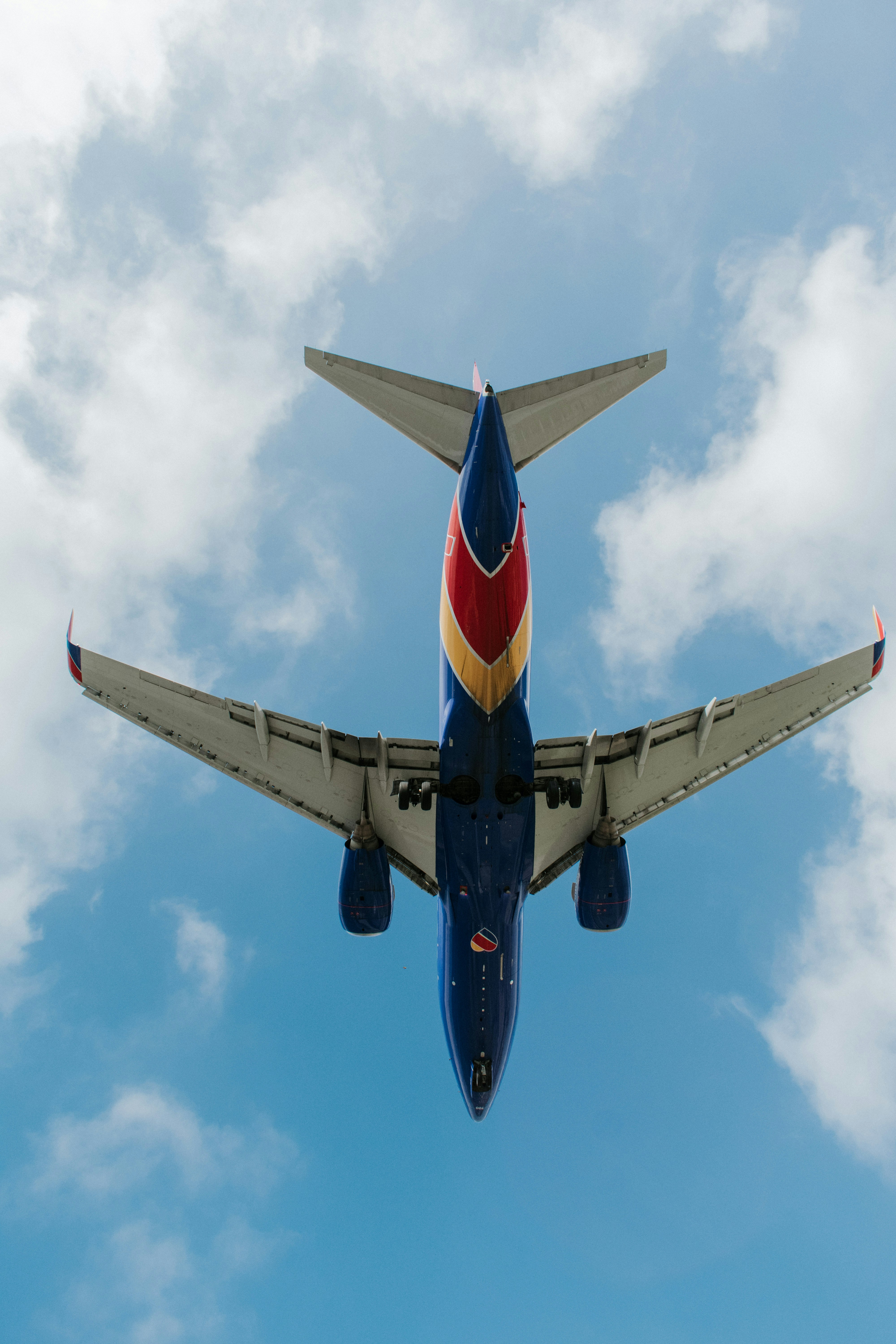 Blue and red airplane flying in the sky during daytime photo – Free ...