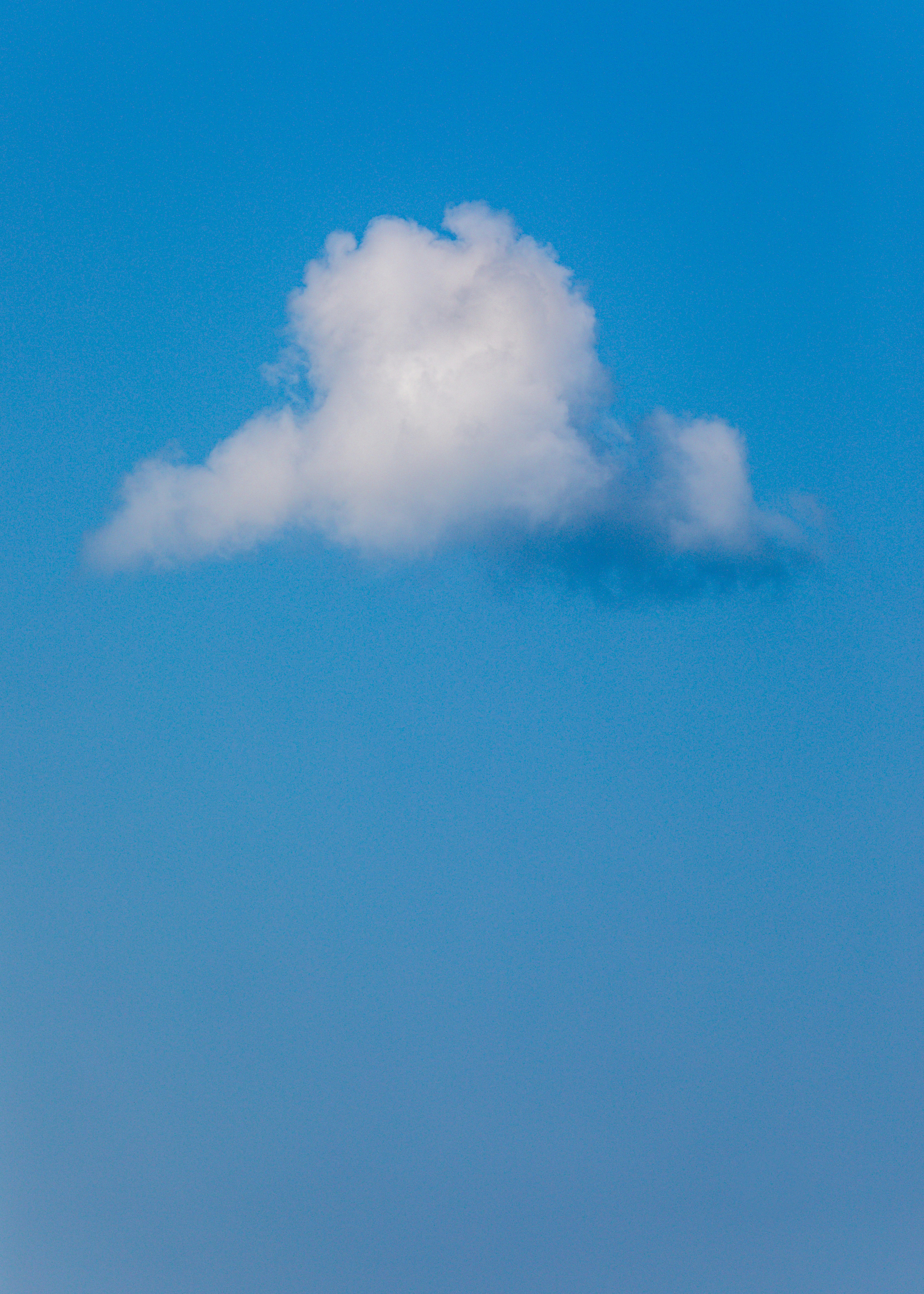 A Lone Cumulus on a Cerulean Canvas