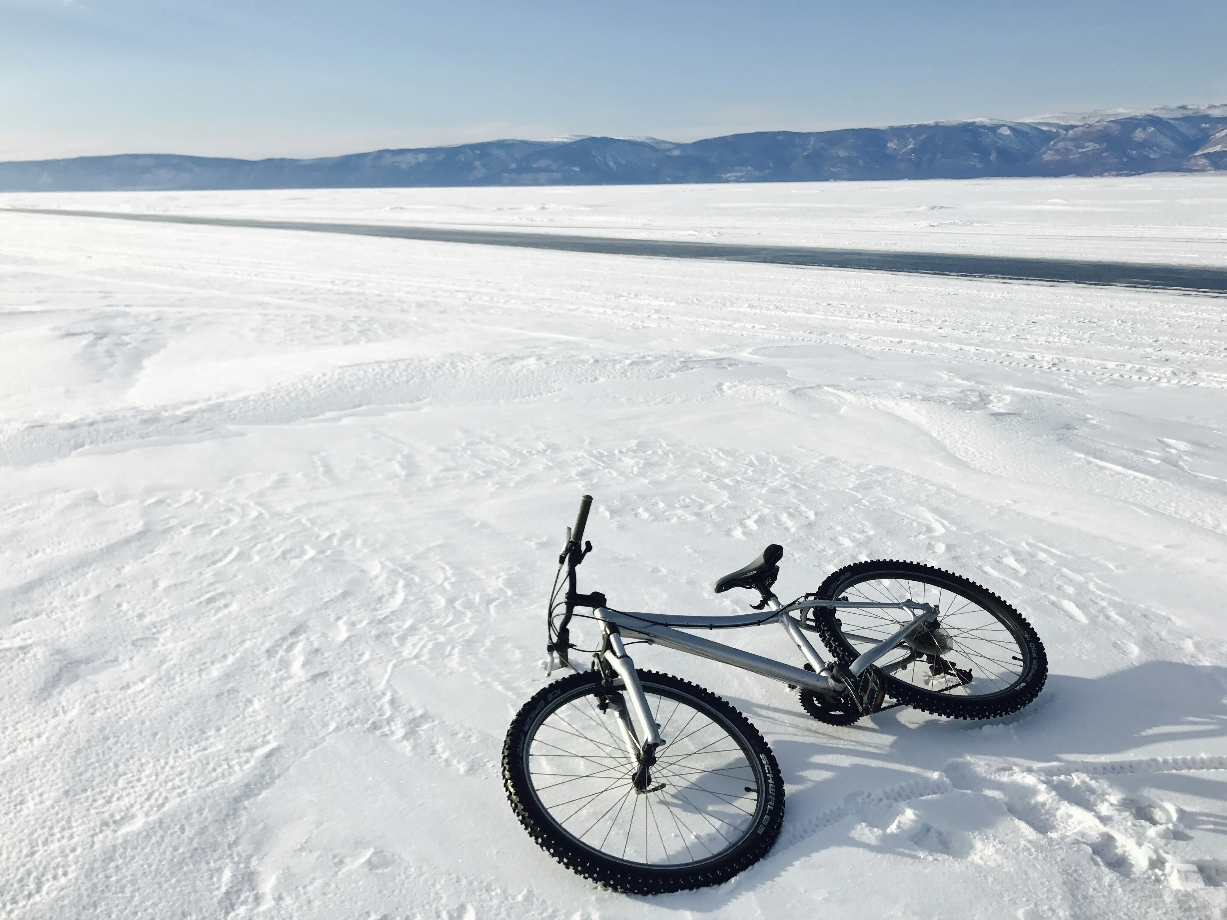 Frozen Frontier: A lone mountain bike anchors a vast snowfield