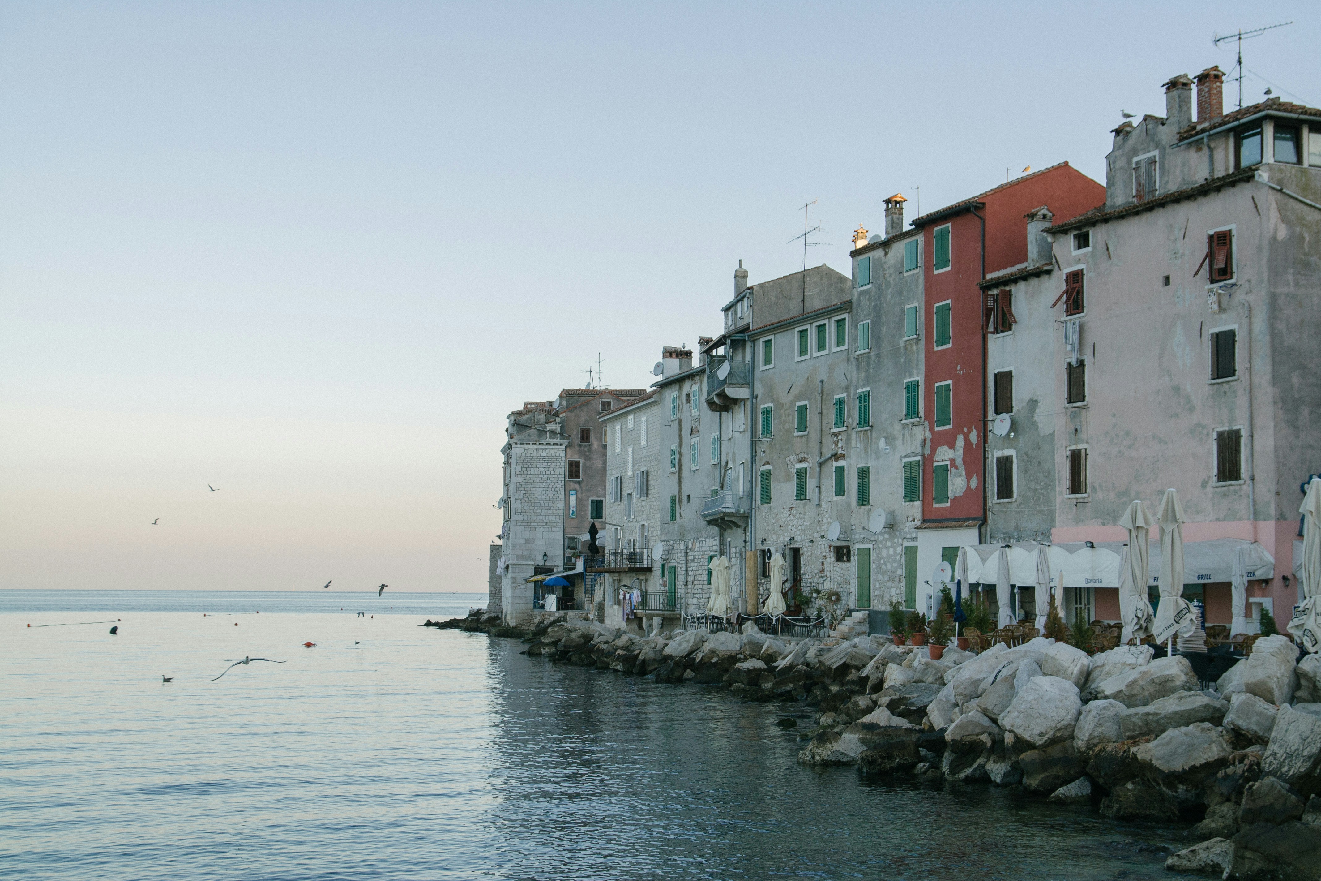 white and brown concrete buildings beside body of water during daytime