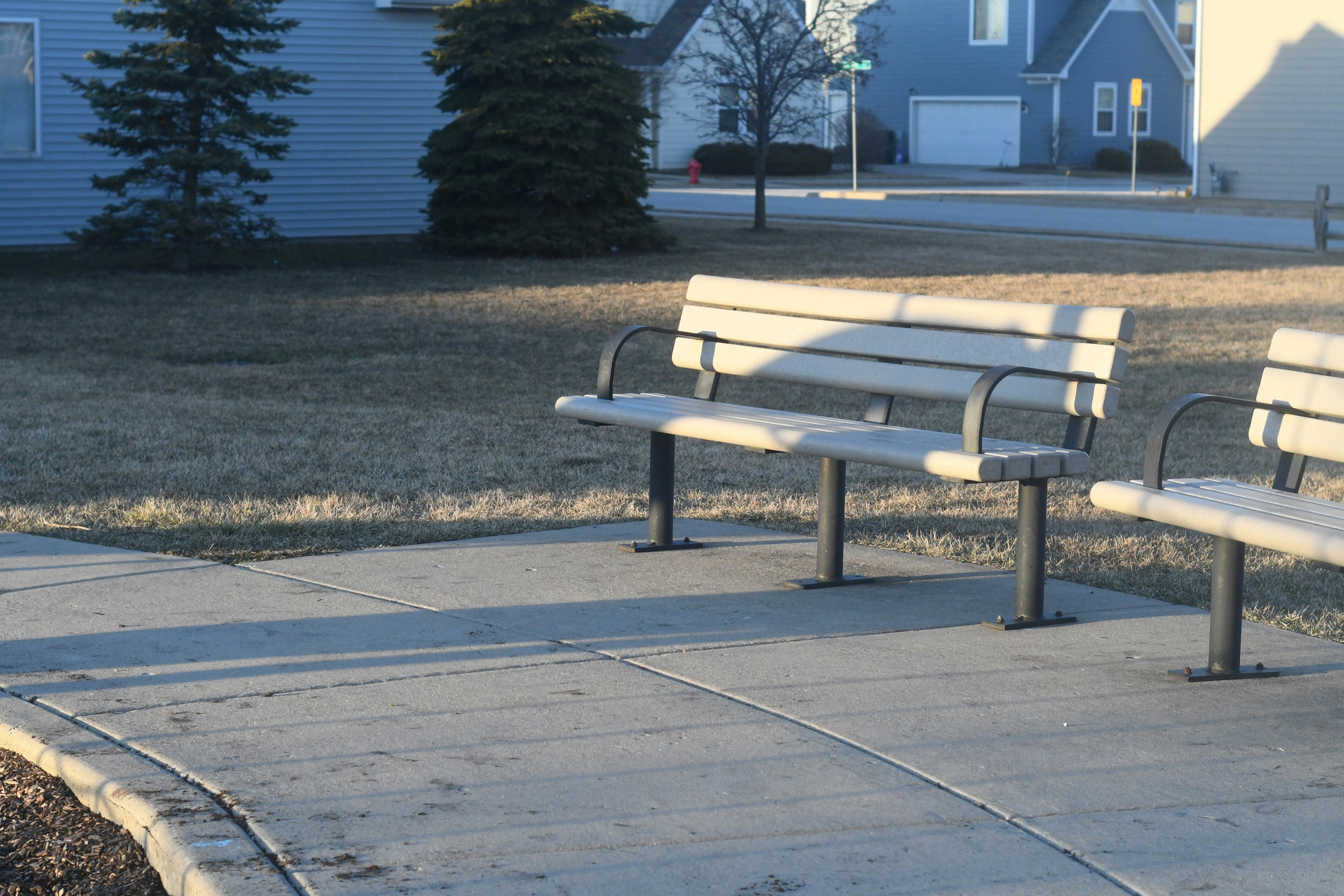brown wooden bench on gray concrete floor
