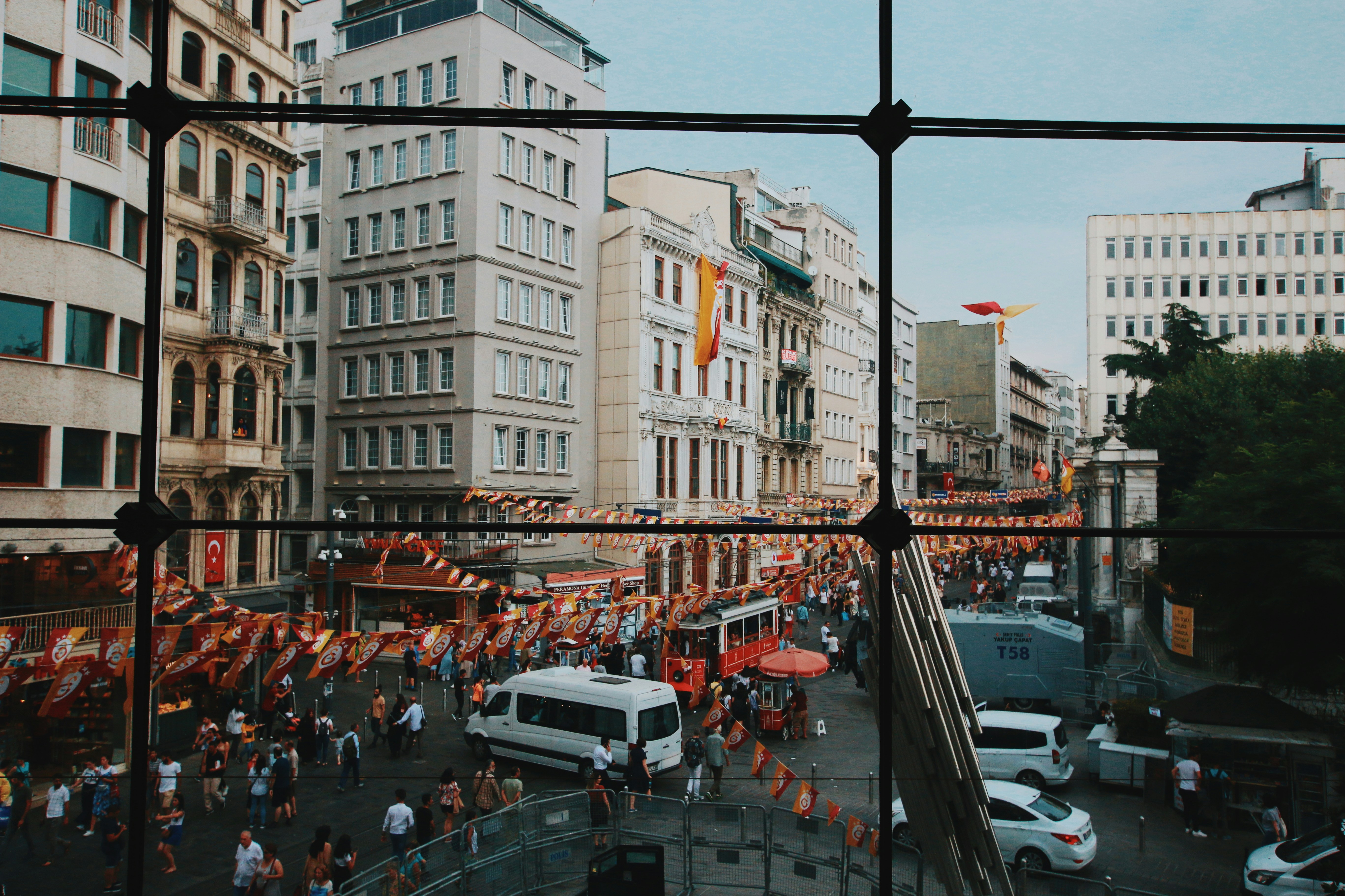 Gridscape of a City Festival: Color and Crowds on a Sunlit Avenue