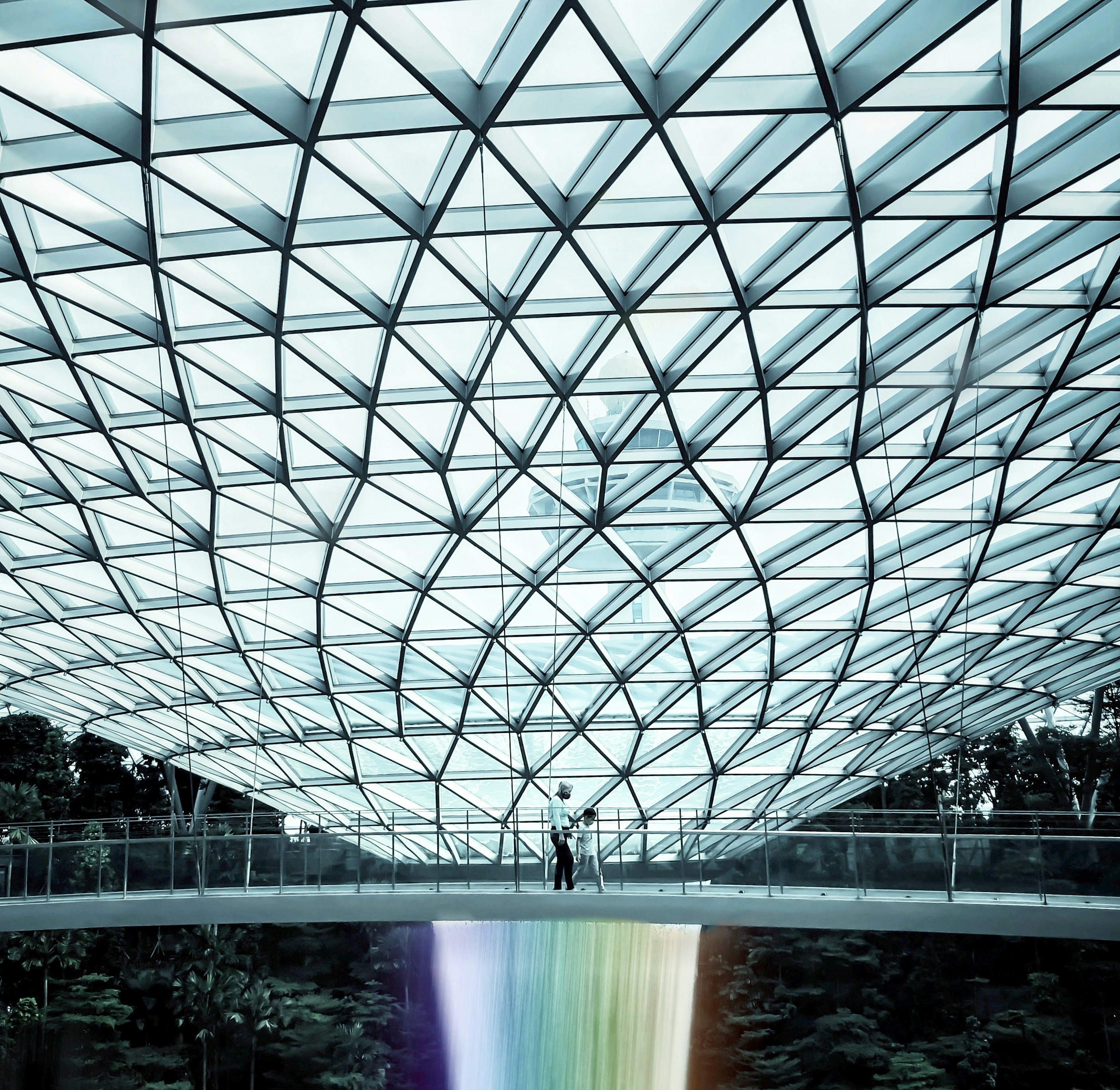 Bridge of Diamond Grids: Silhouettes Above a Rainbow Cascade