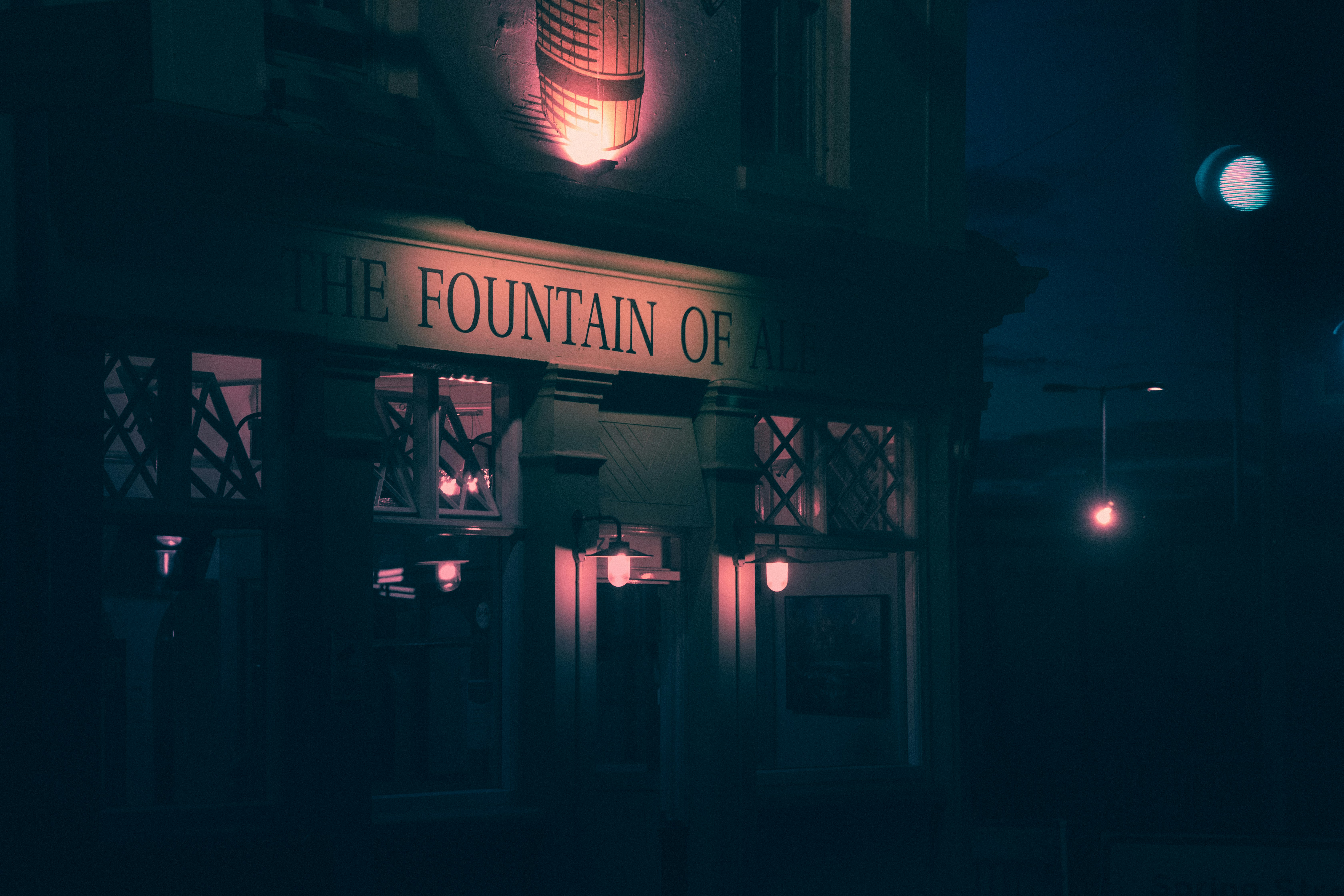 brown wooden store with lights turned on during night time