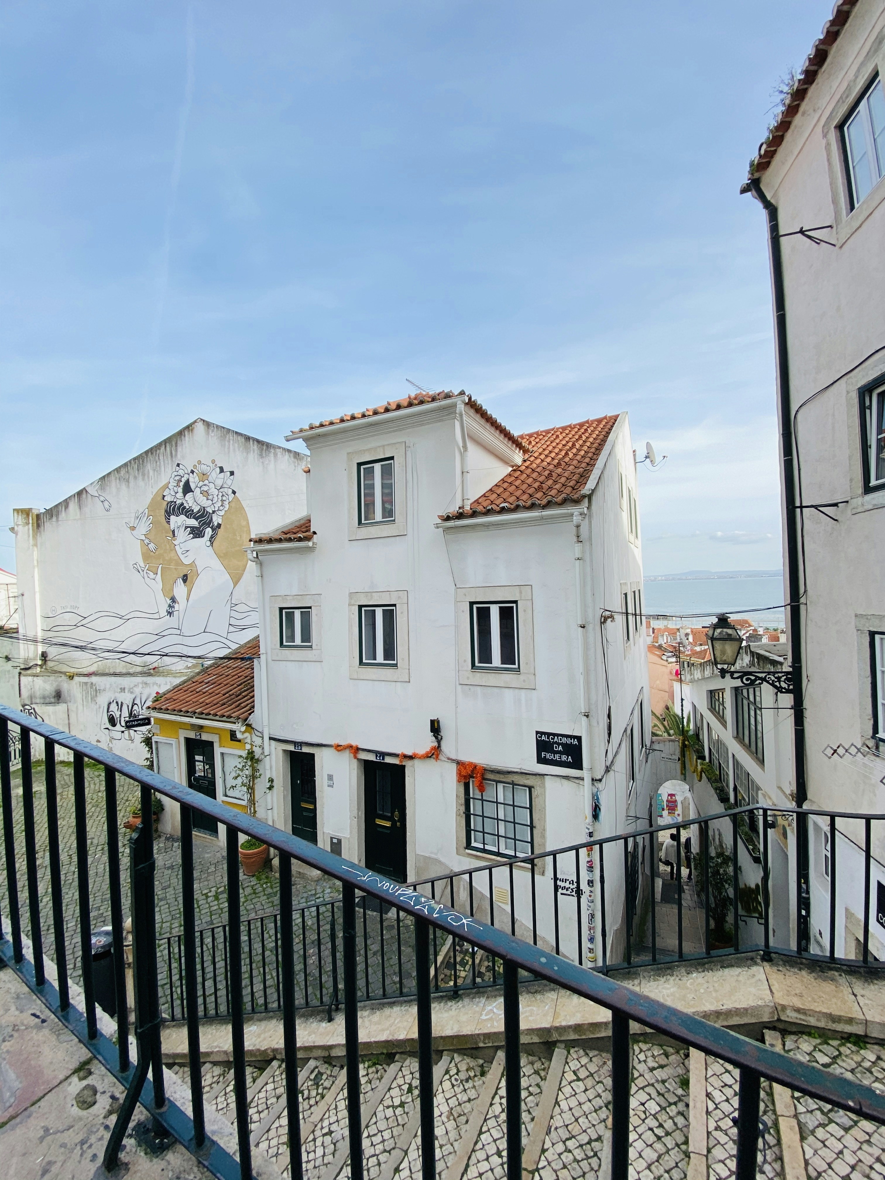 Whimsical Street Art in Alfama's Sunlit Alley