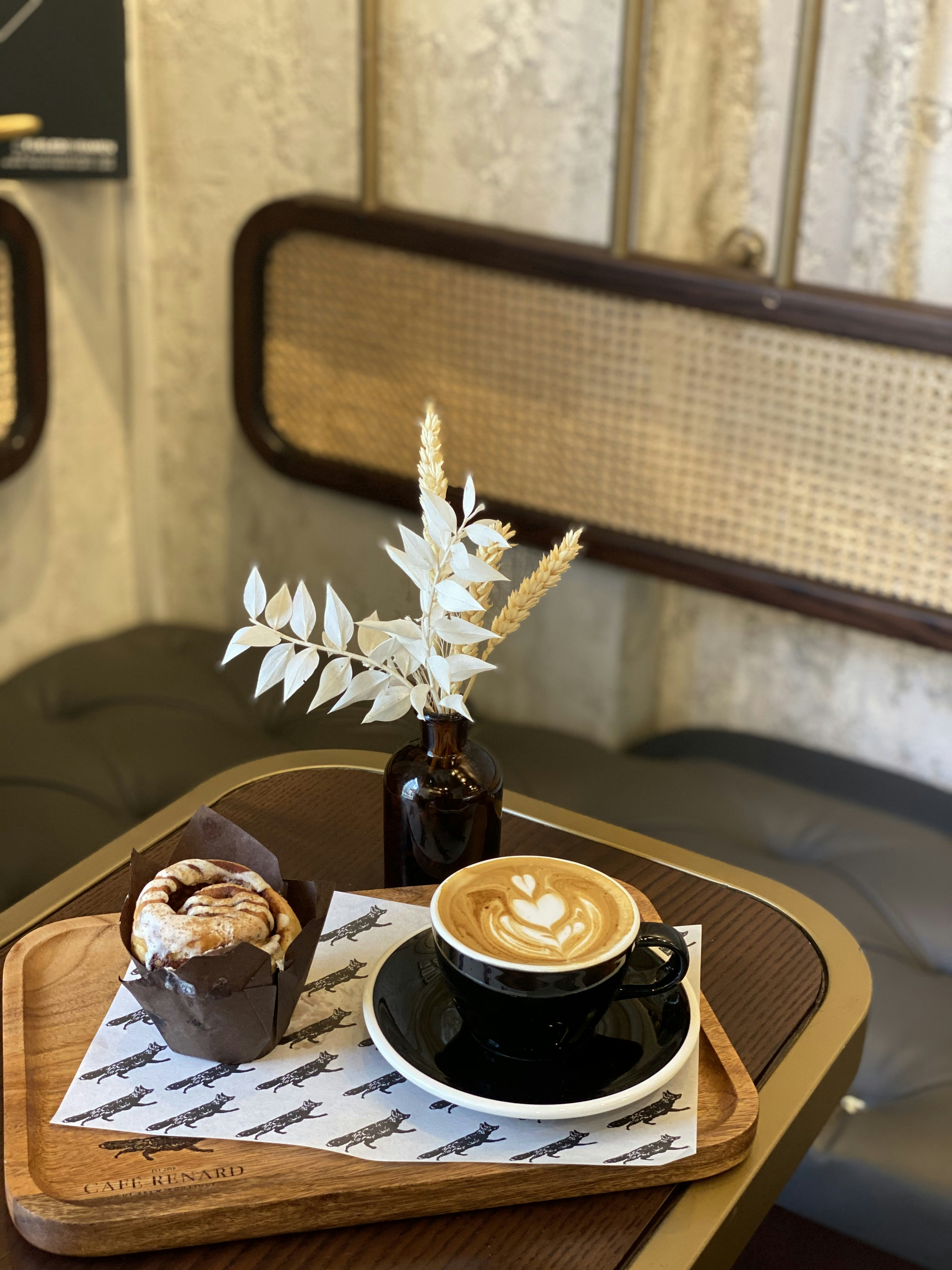 Latte Art in a Vintage Café Nook: Pastry, Dried Blooms, and Warm Ambience