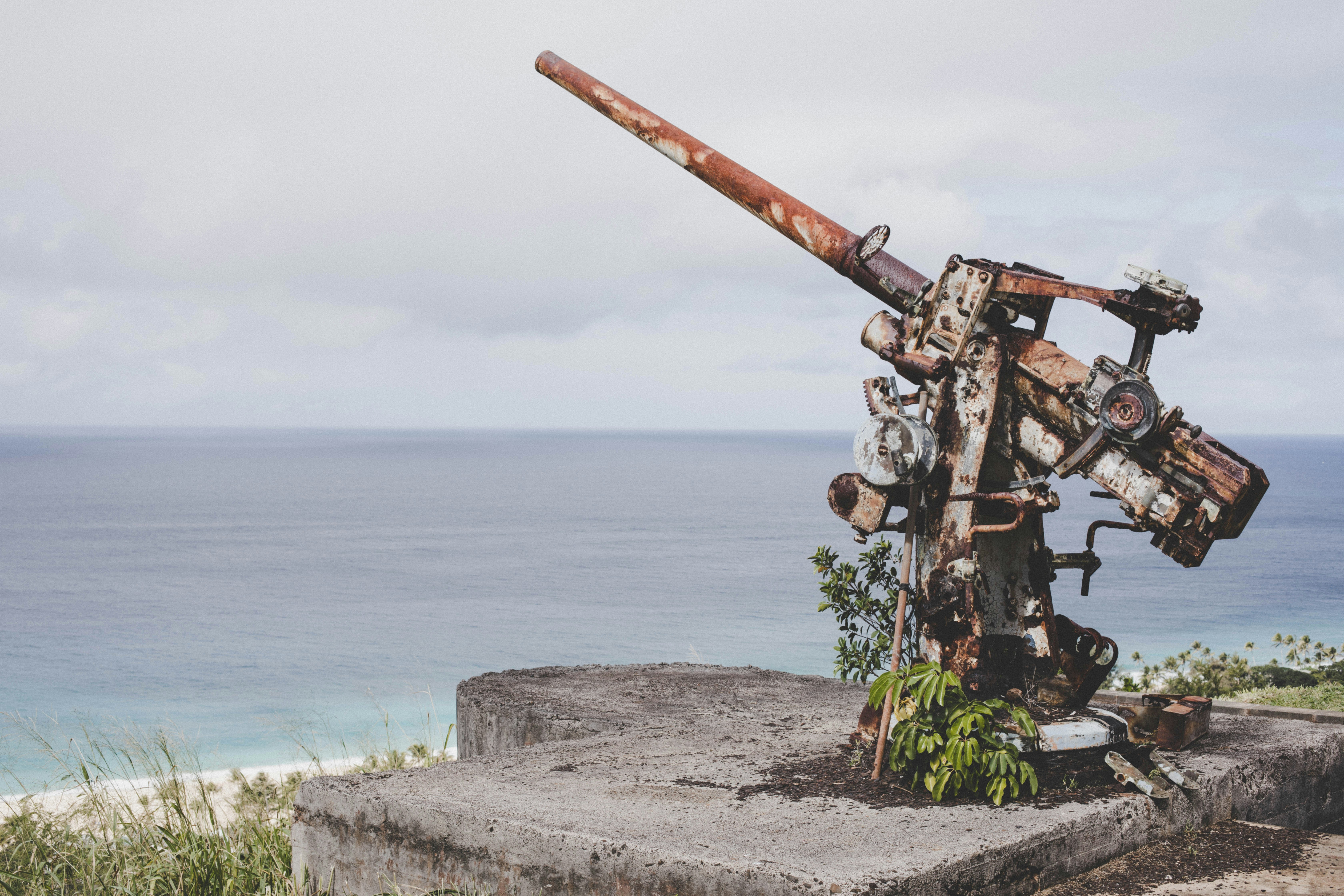 Maui, HI | brown metal machine on gray concrete wall near sea during daytime