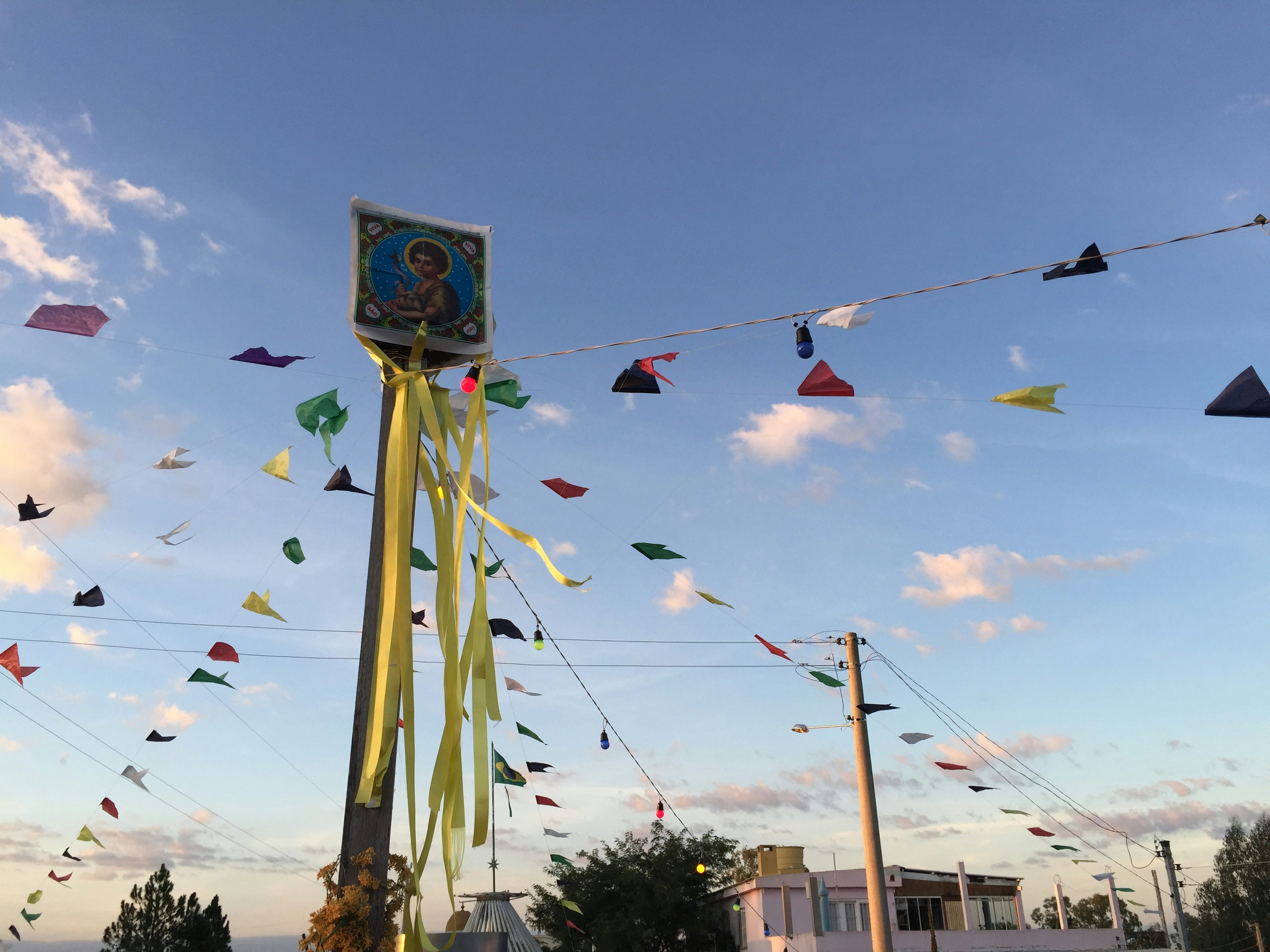 Kite Flags and a Festive Pillar under an Open Sky