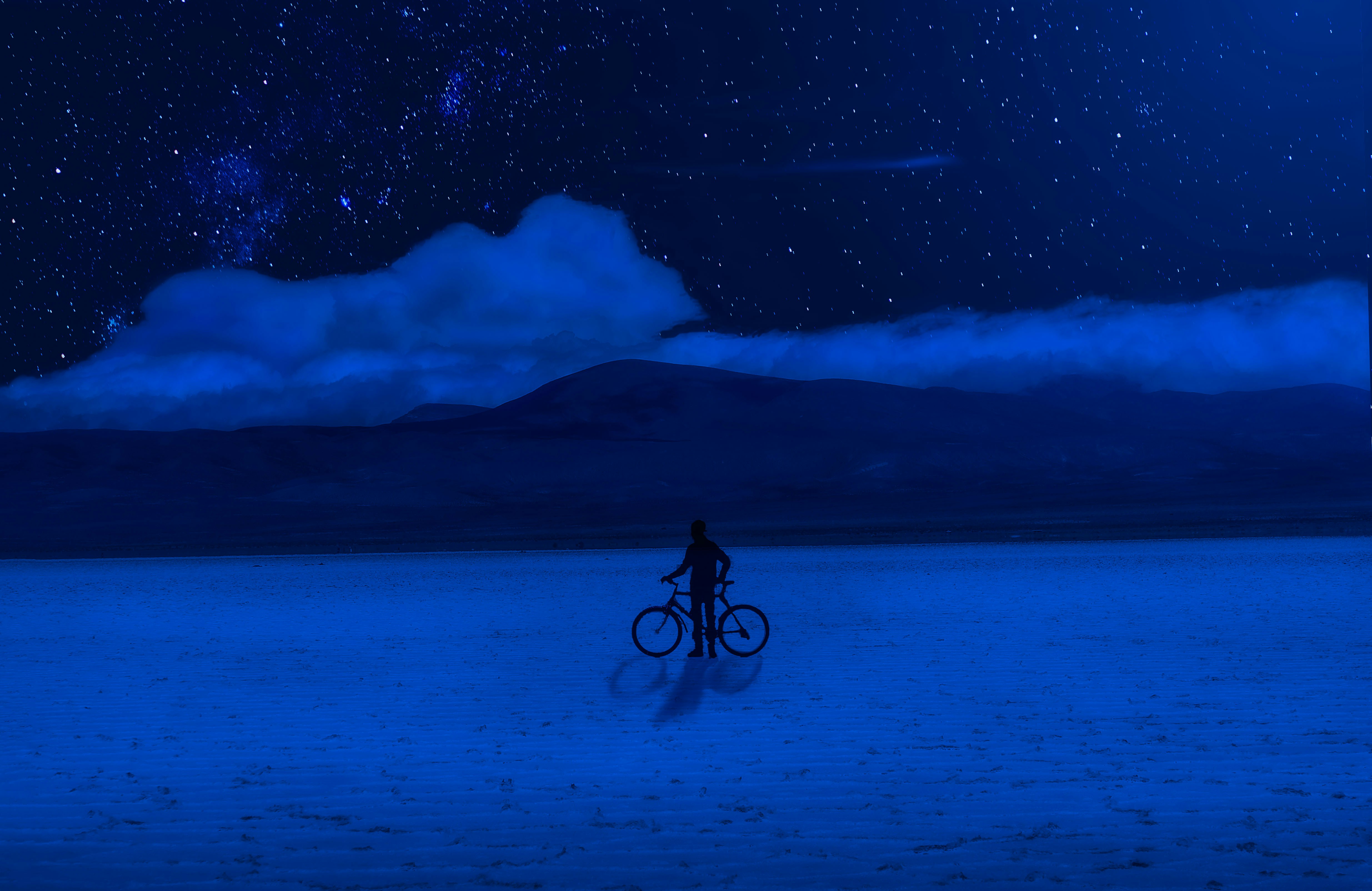 Blue-Hour Rider: Silhouette on a Star-Strewn Salt Flat