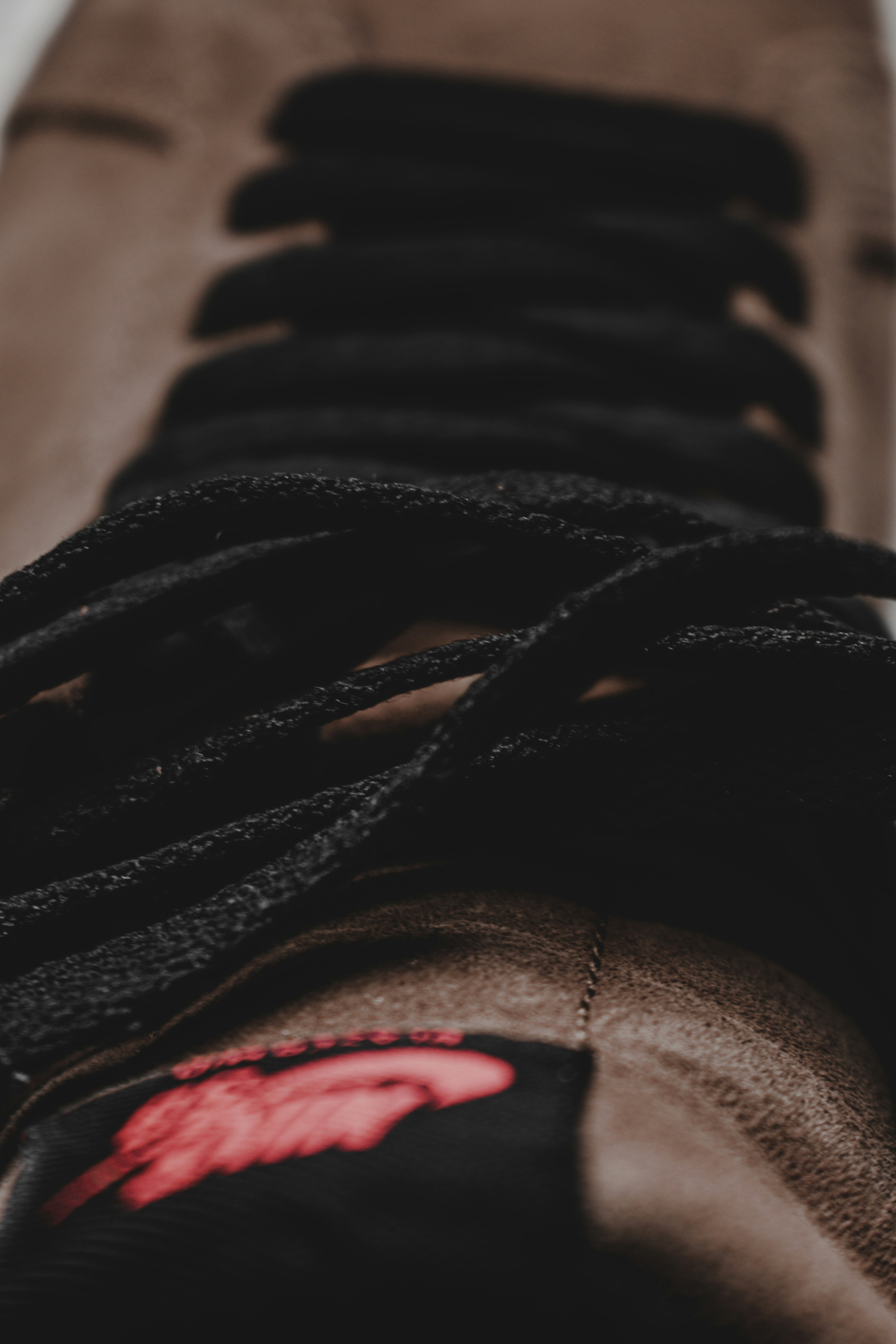 Lace and Leather: A Close-Up of Knotted Shoelaces on a Dark Leather Boot