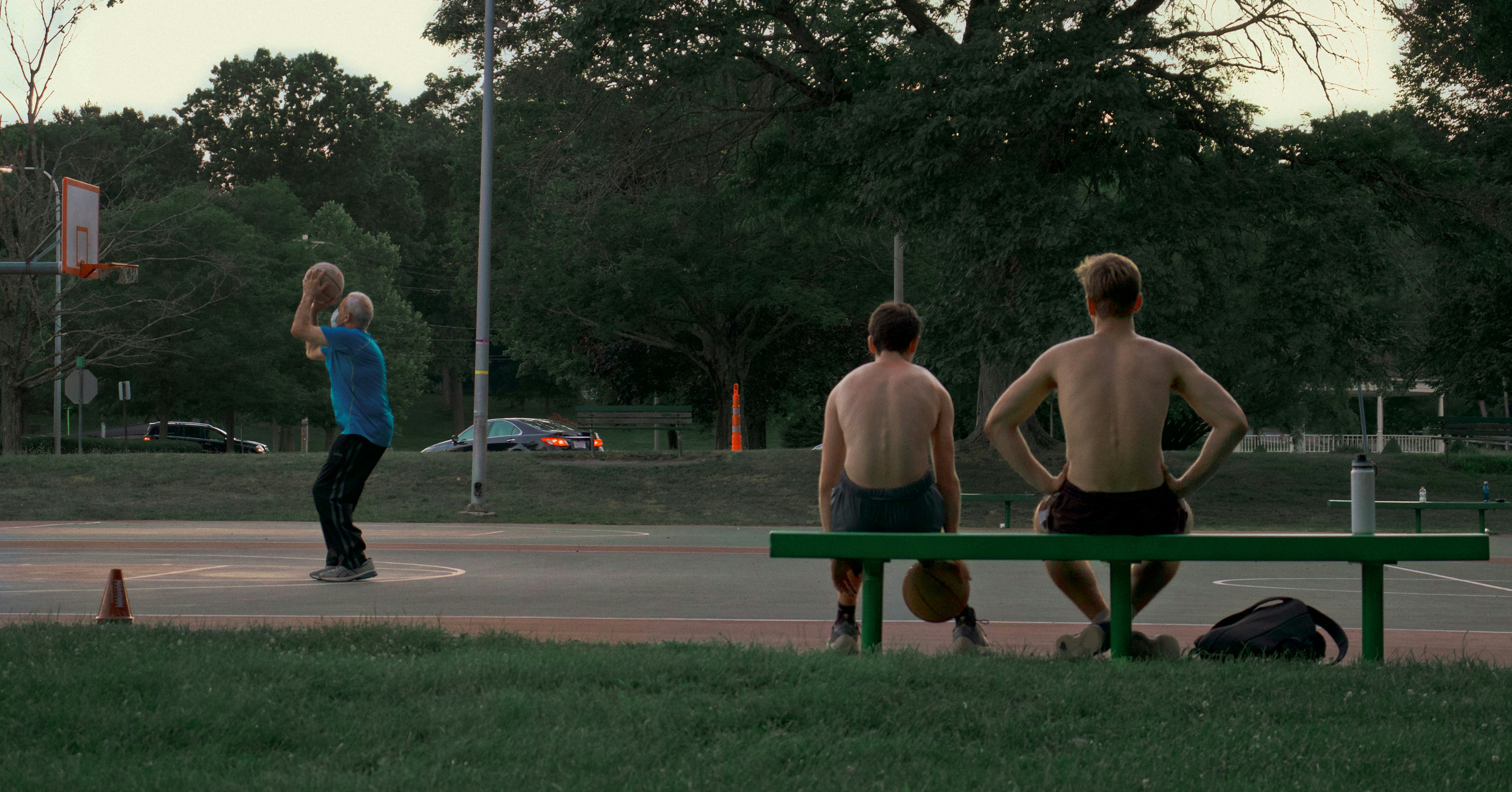 Dusk on the Park Court: A Jump Shot and Two Spectators