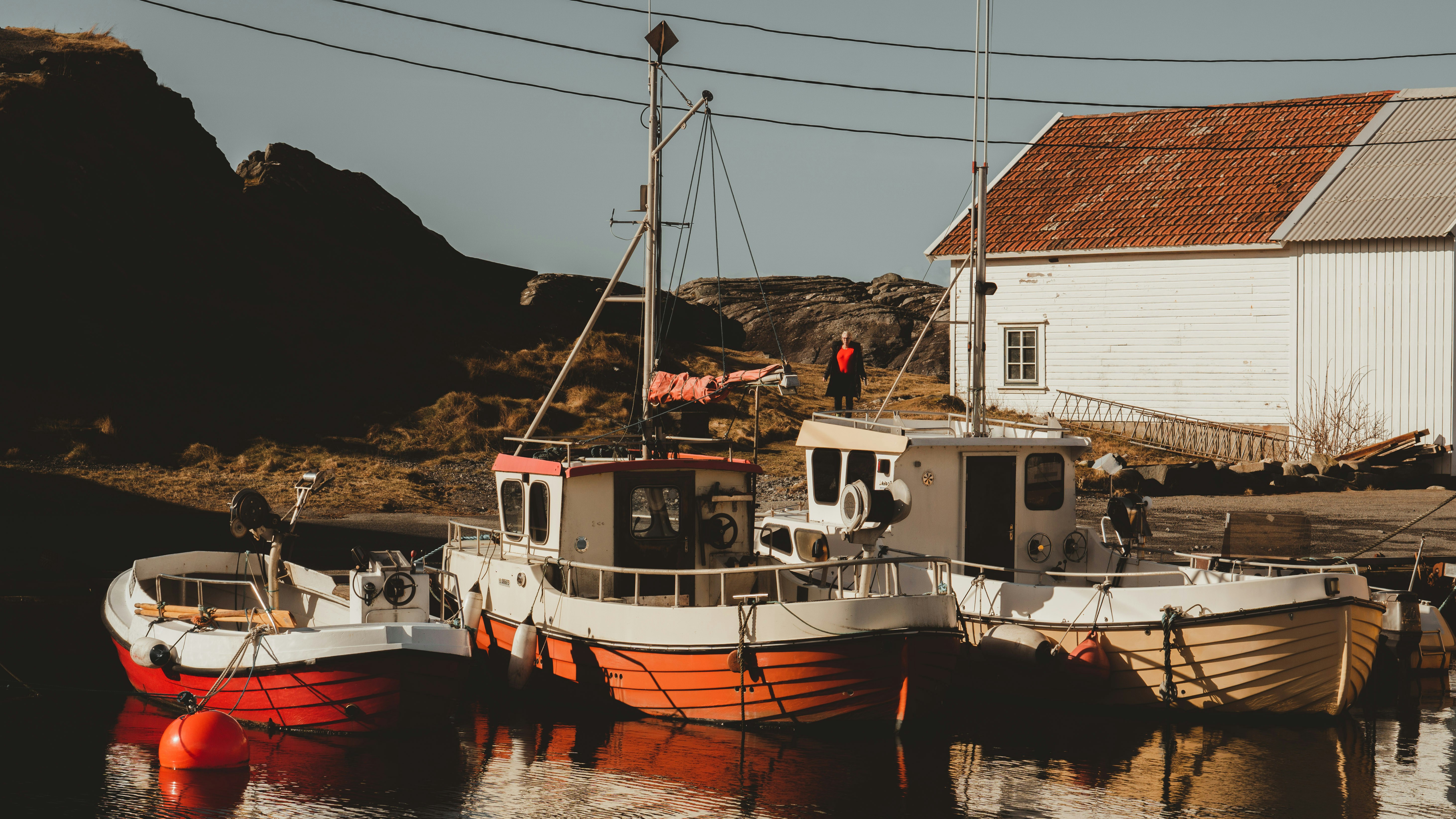 white and red boat on body of water during daytime