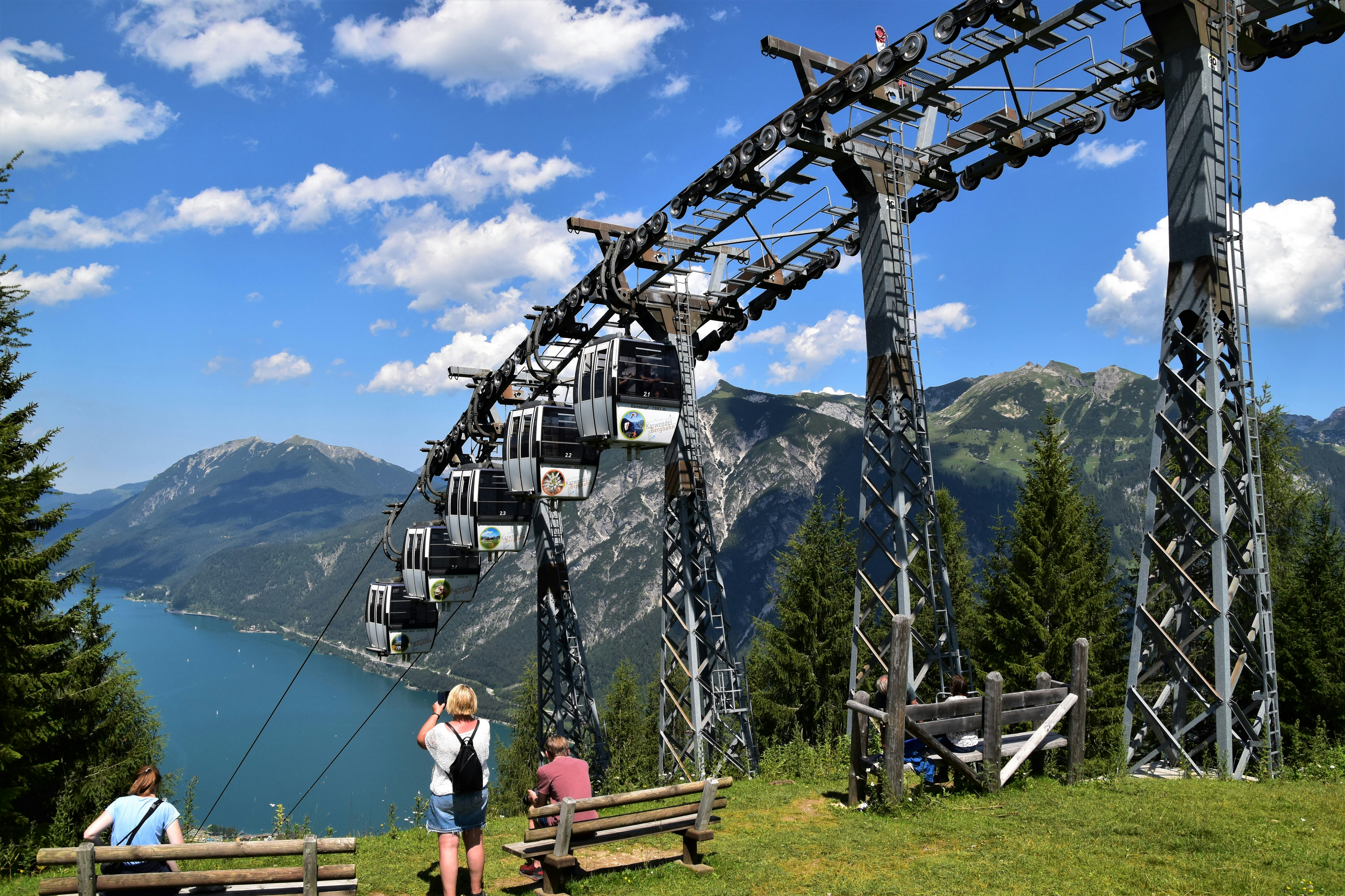 Gondolas on a Steel Spine Above a Turquoise Alpine Lake