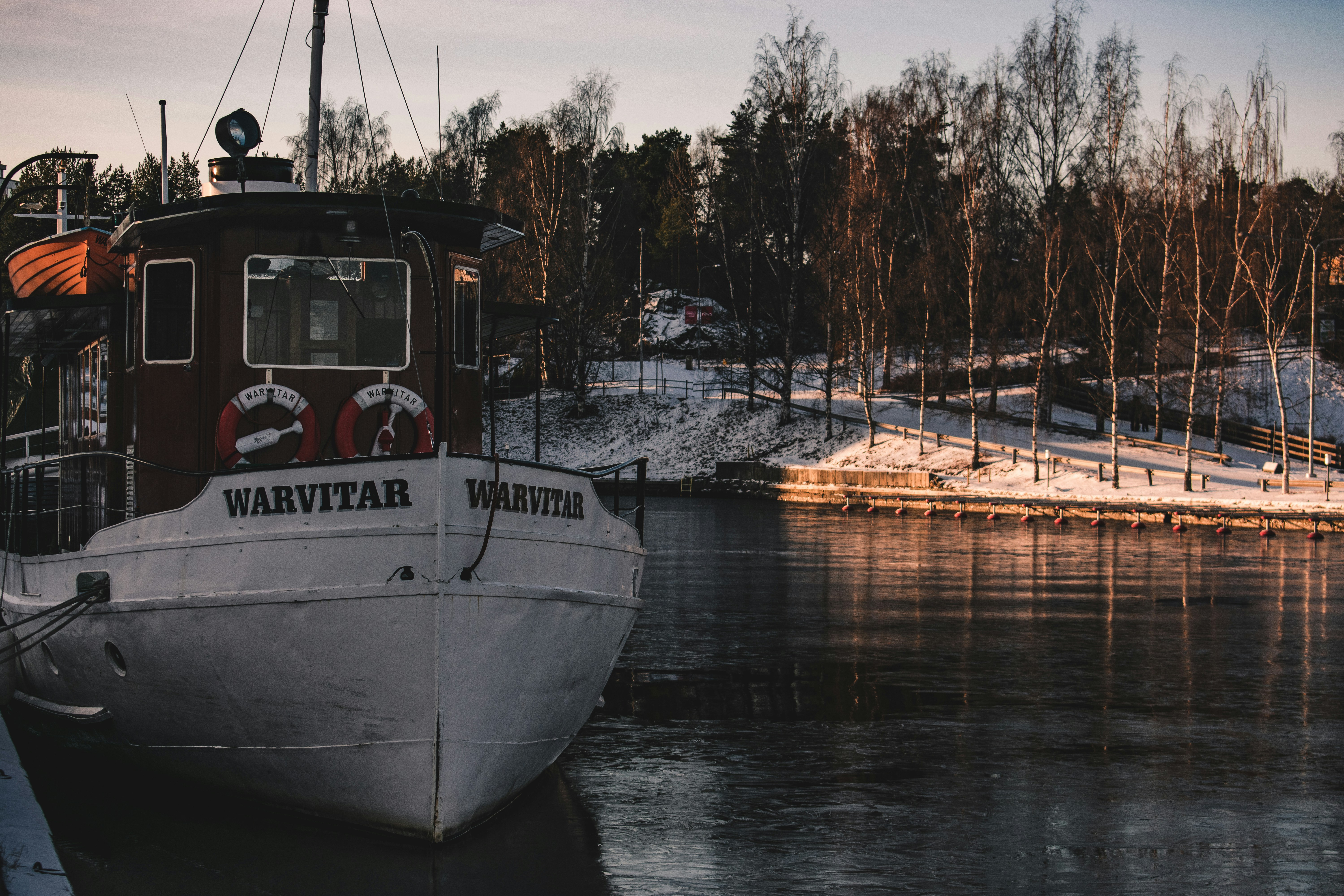 white and blue boat on water during daytimeMary Ray
