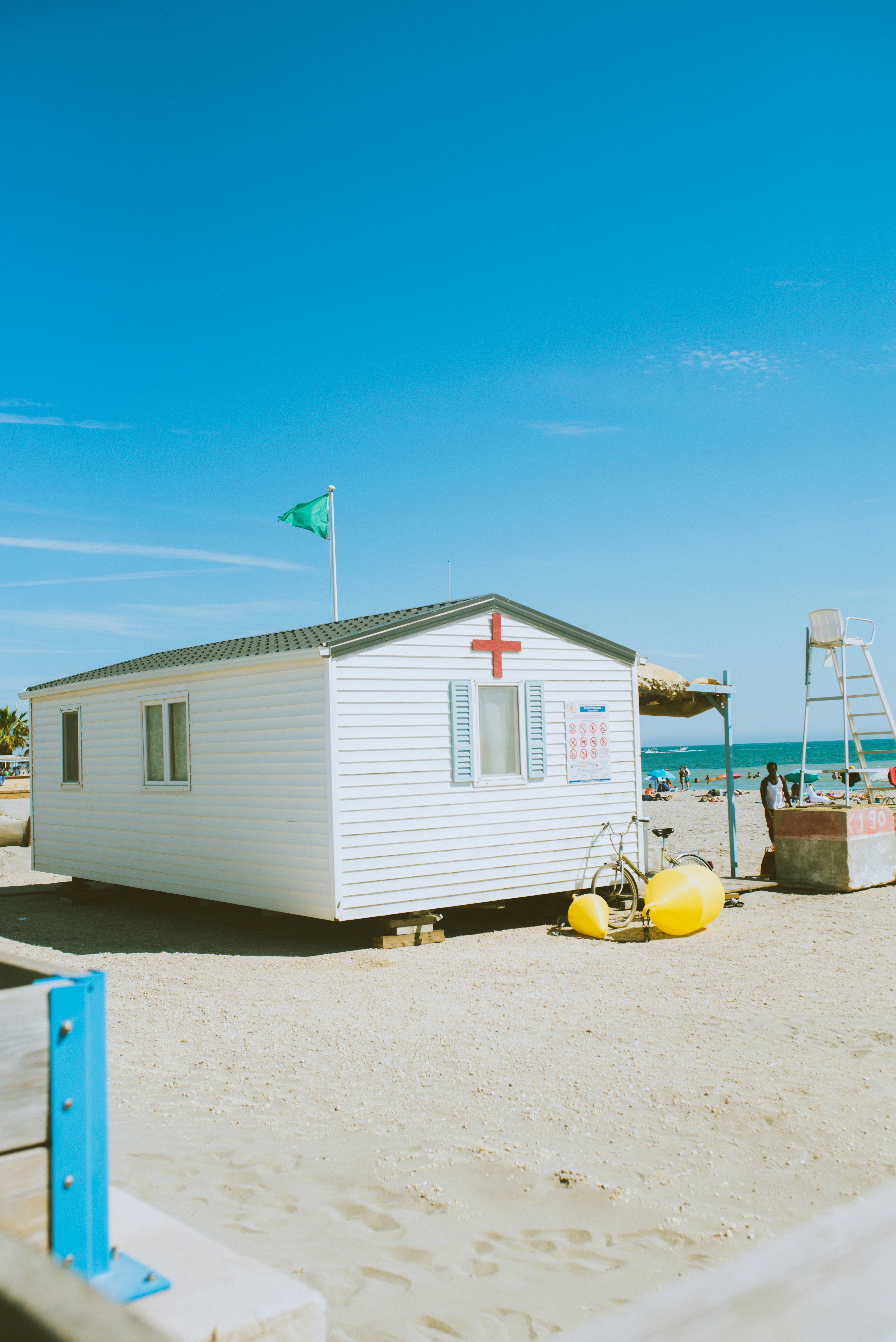 Red-Cross Lifeguard Cabin on a Sunlit Seashore