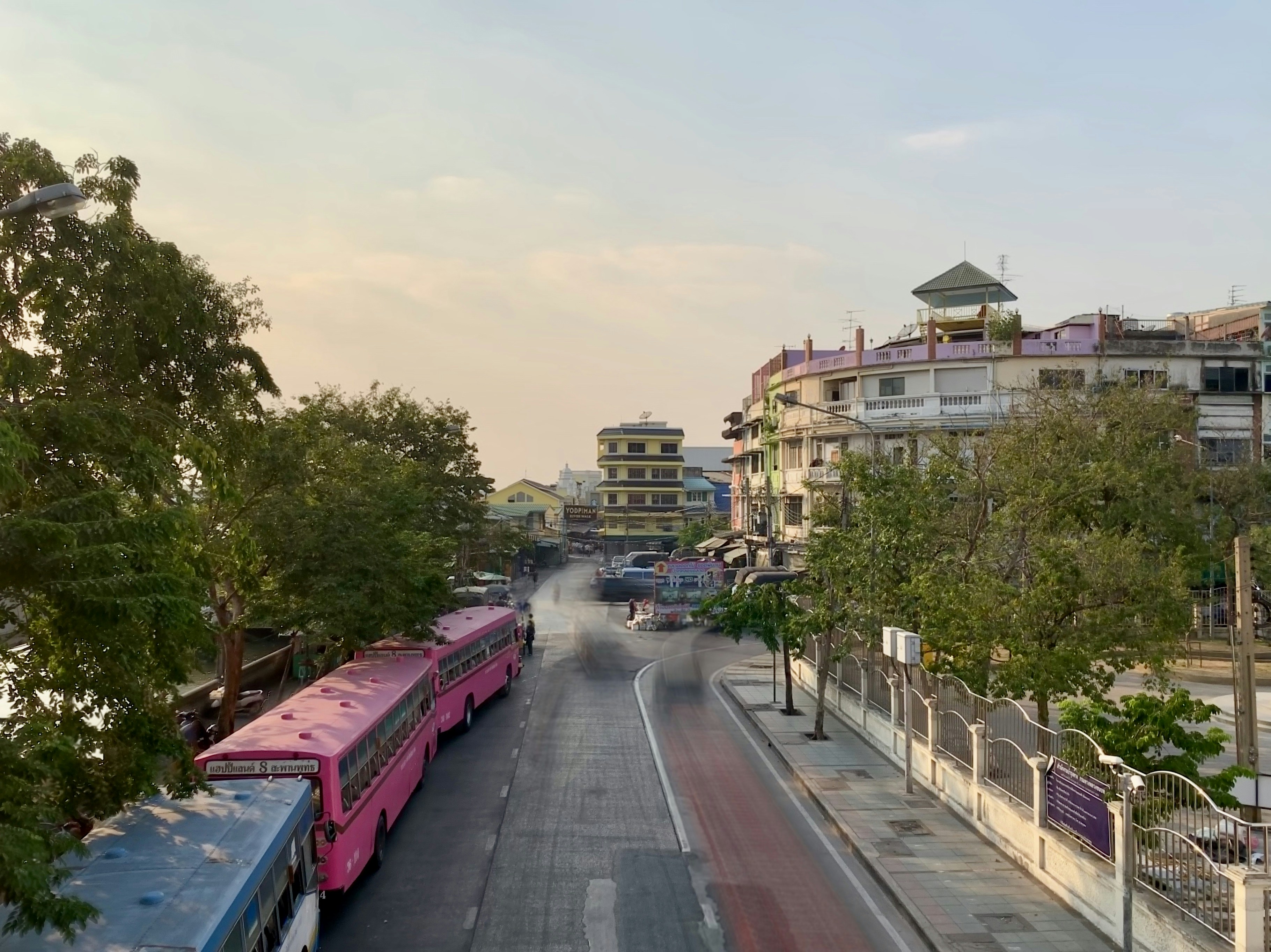 Pastel Transit: Pink Buses Converge Toward a Quiet Vanishing Point