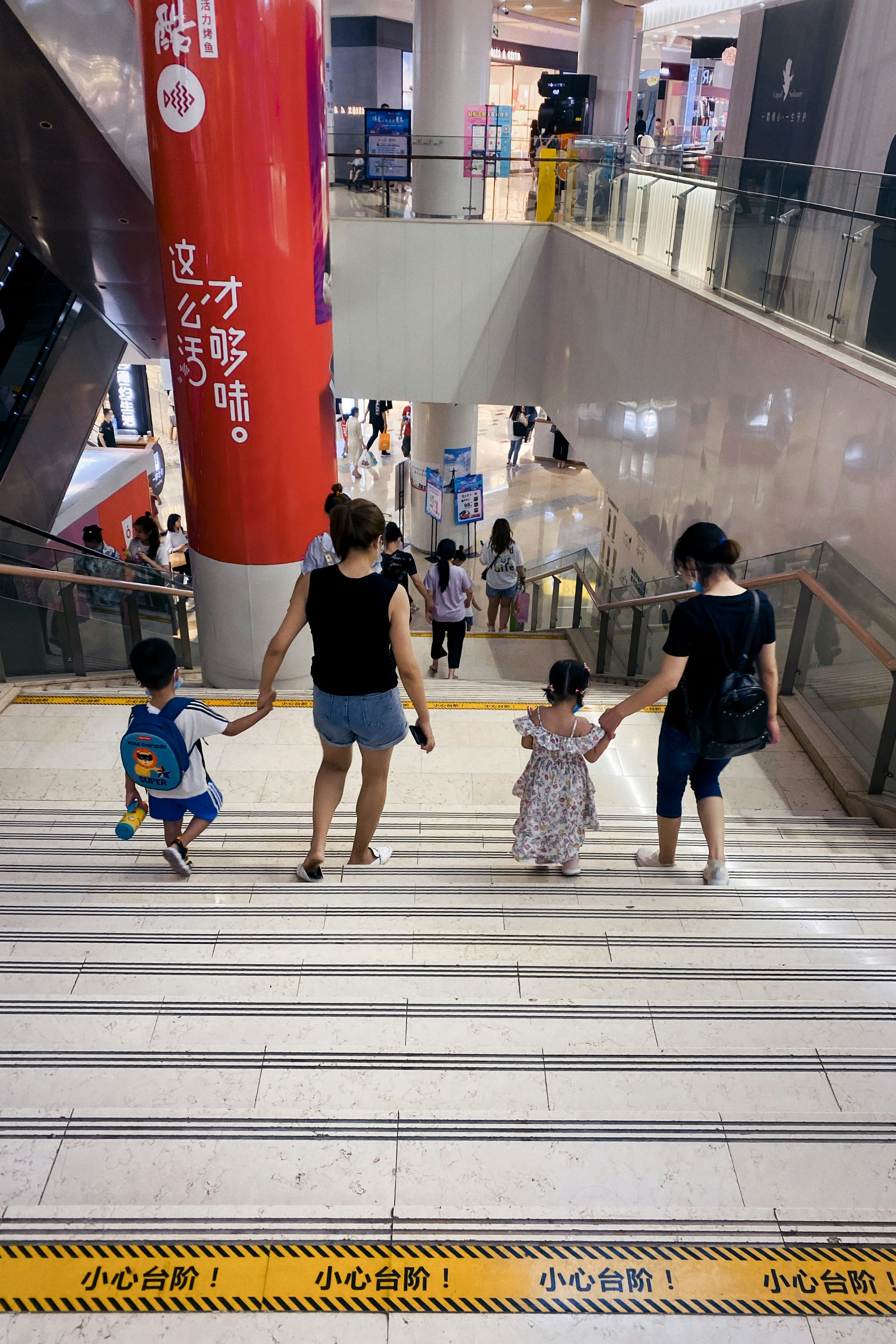 Hands Across the Mall Stairs: A Family Pause on a Busy Day