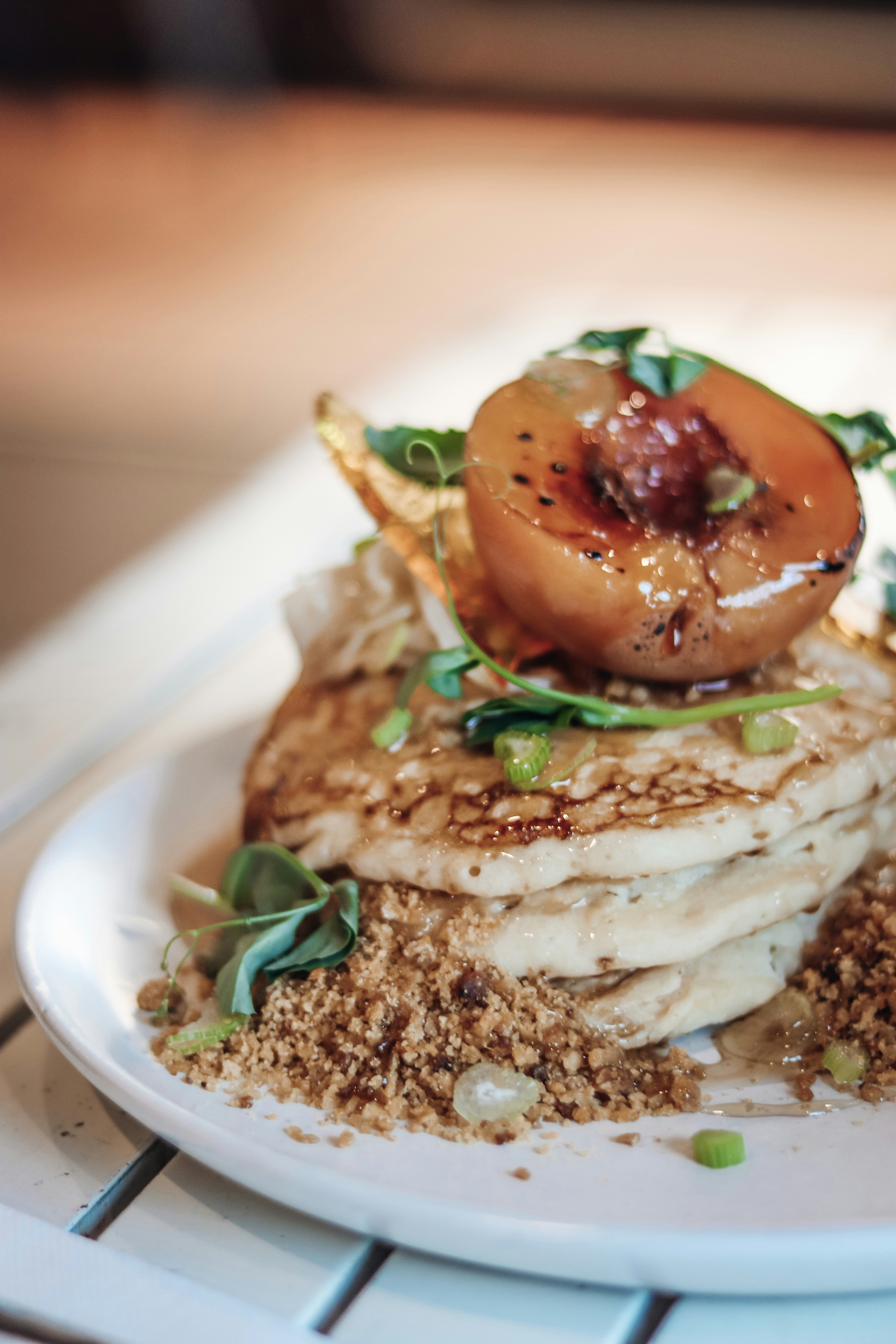 Stacked Pancakes with Caramelized Peach Crown on Crunchy Streusel