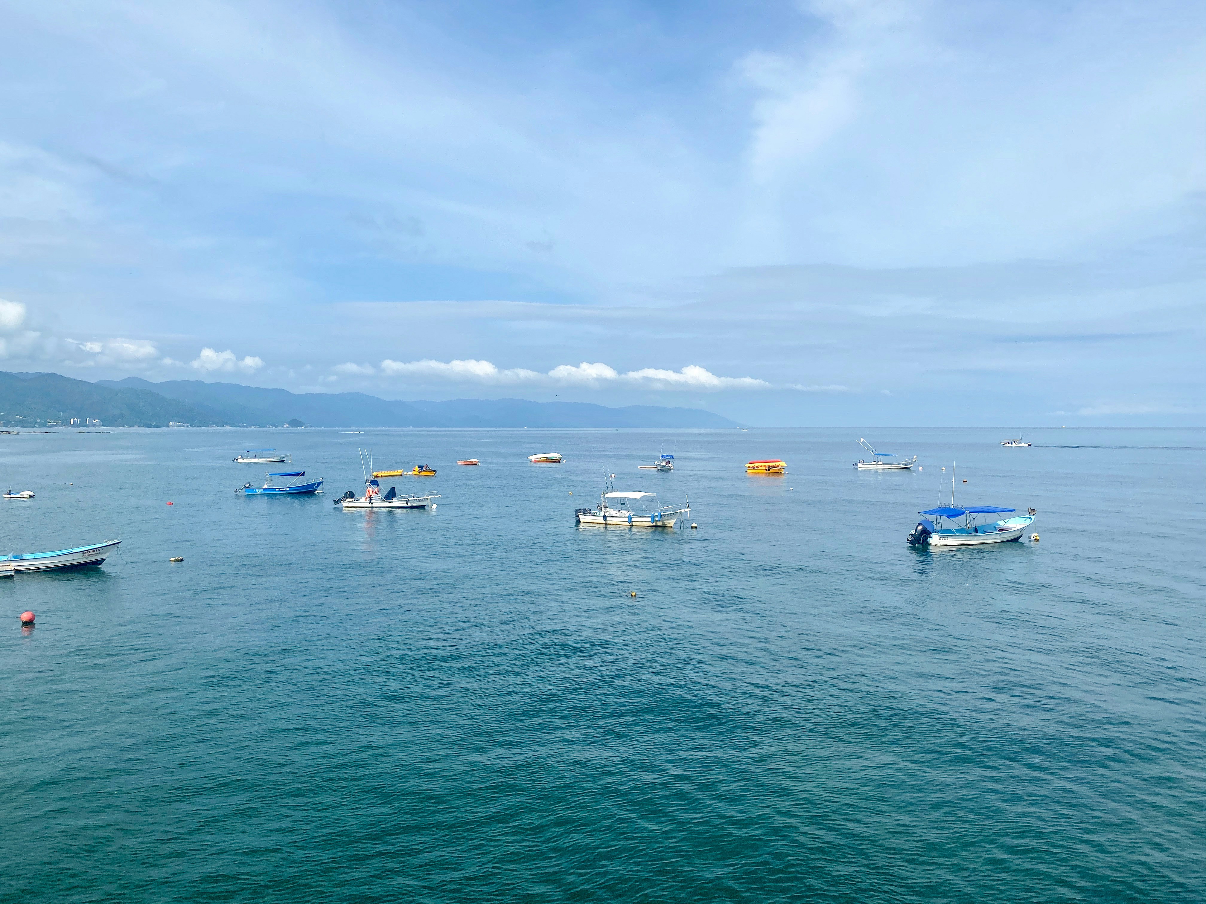 Azure Tranquility: A Fleet of Small Boats on a Quiet Bay