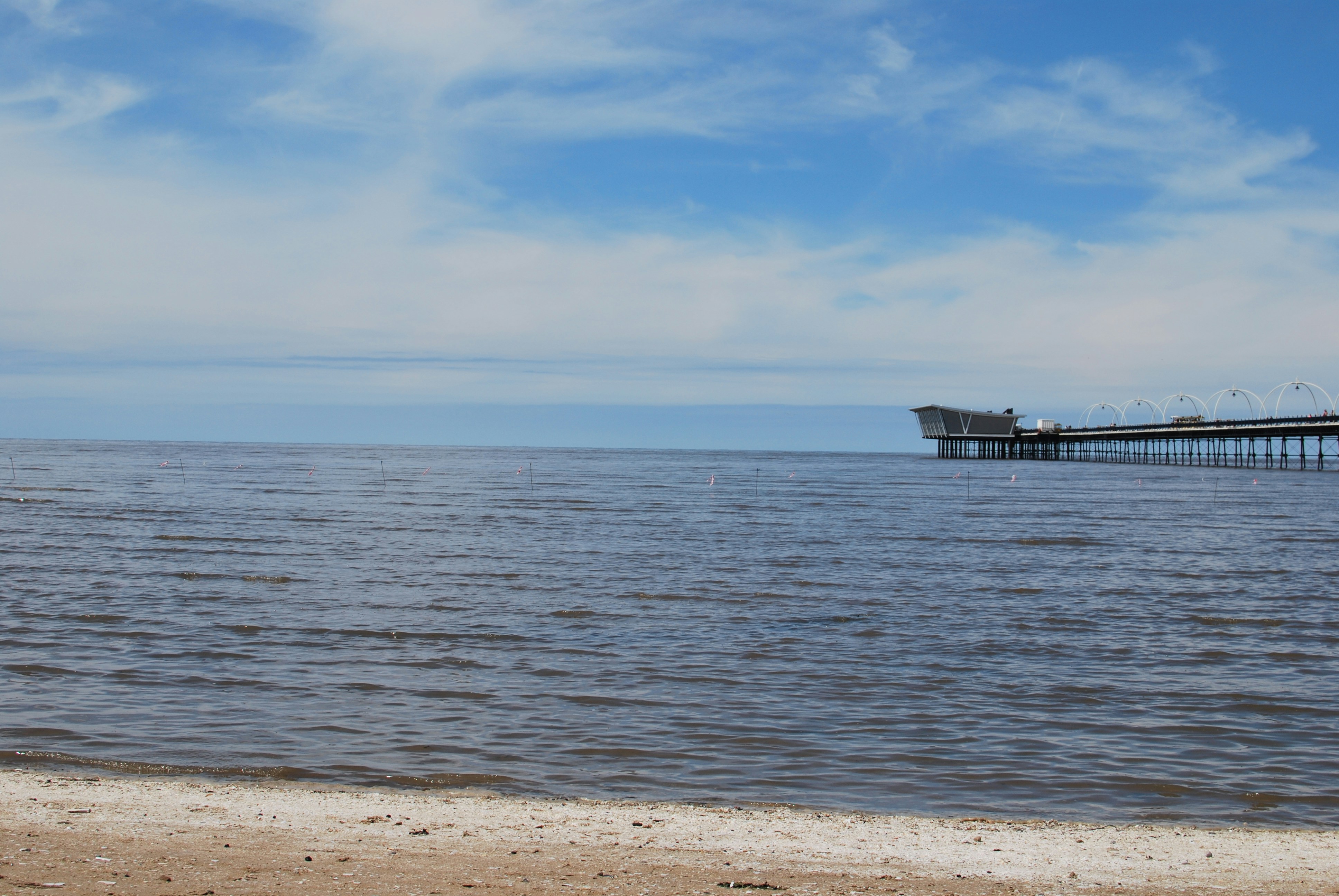 Rightward Pier at the Edge of a Quiet Blue Horizon