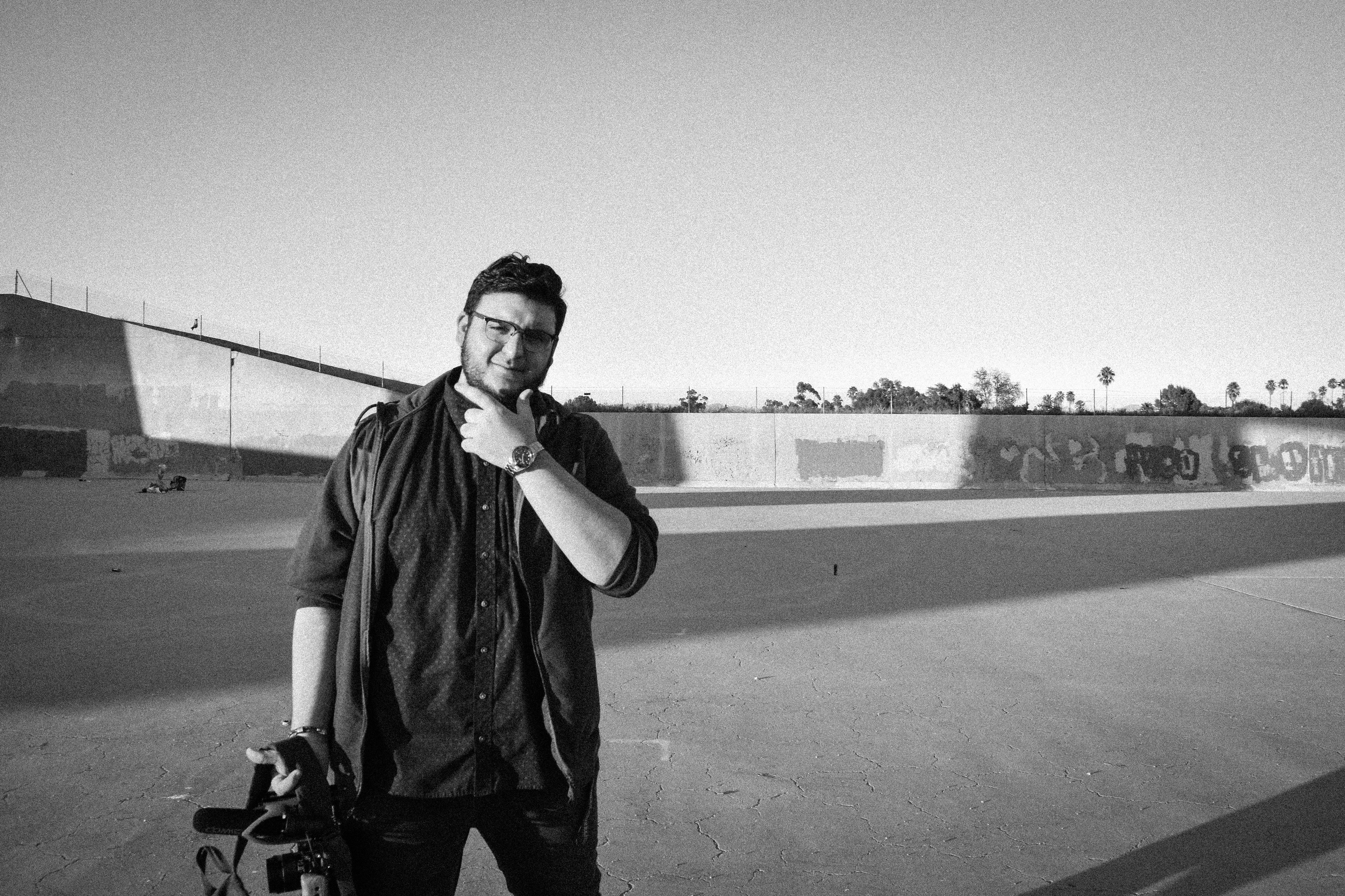 Quiet Focus in the Concrete Bowl: A Videographer Stands with His Lens