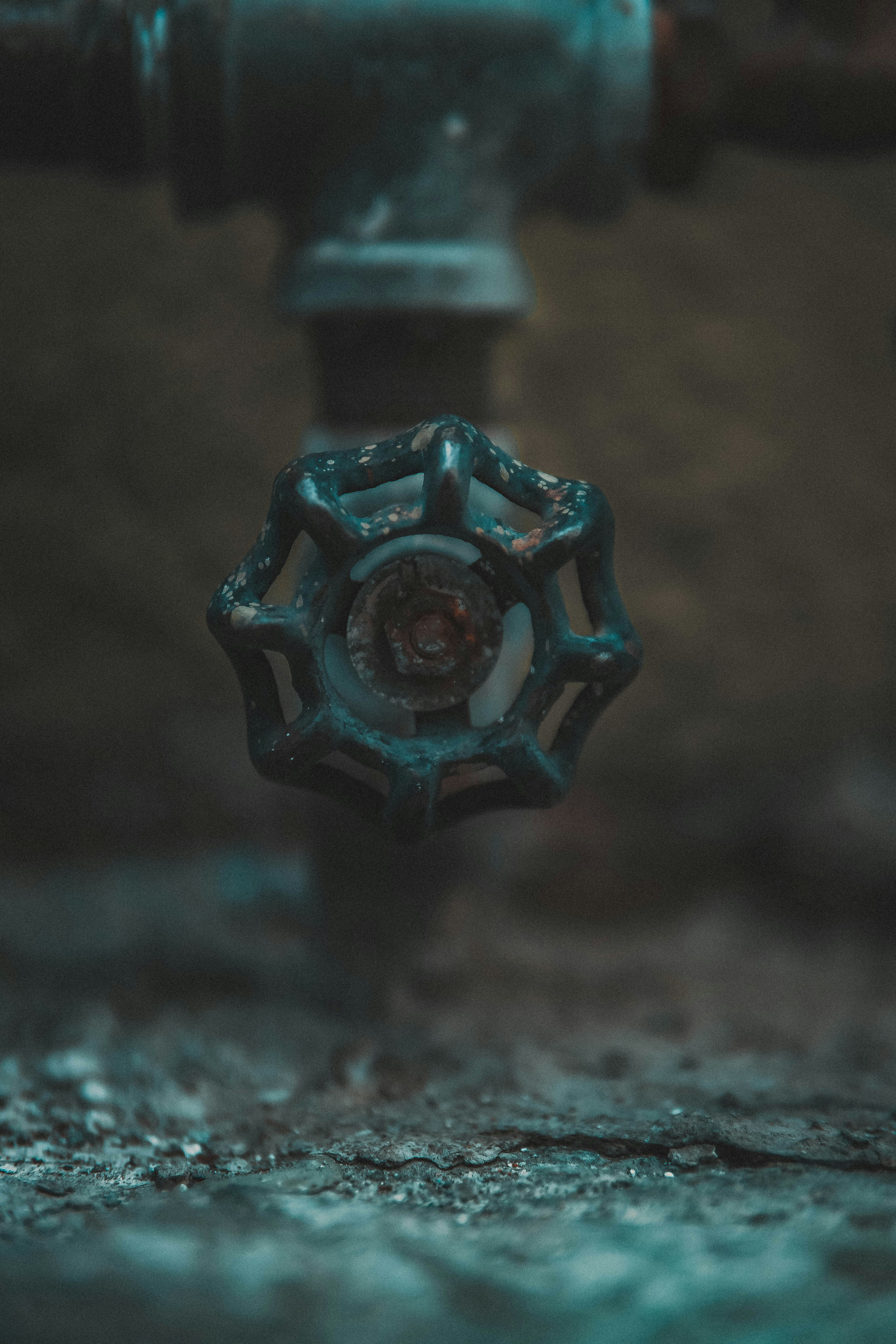 Teal Patina on a Weathered Valve Knob in Dim Industrial Light