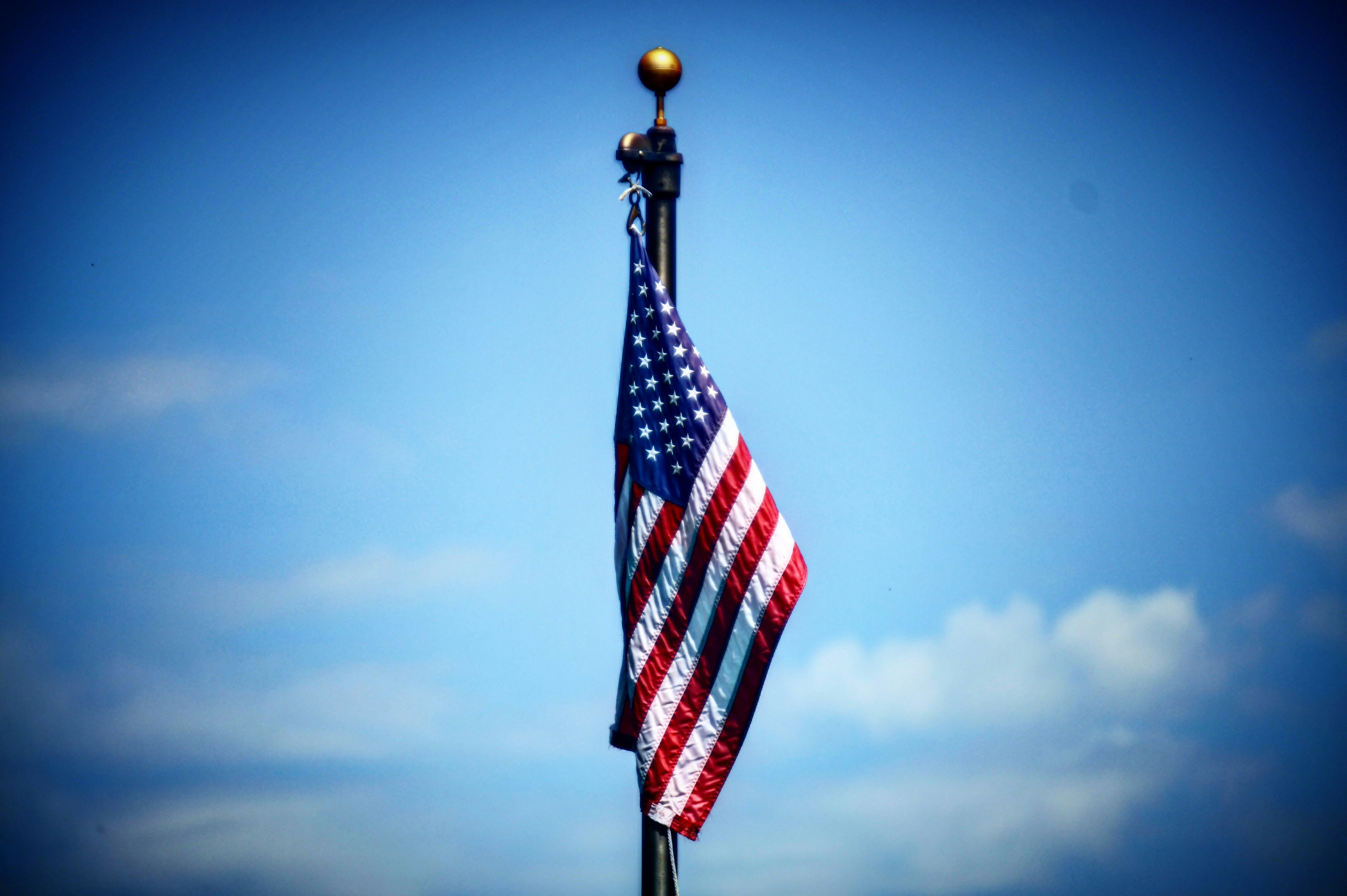 A Lone Flagpole Reaching Into a Cerulean Sky