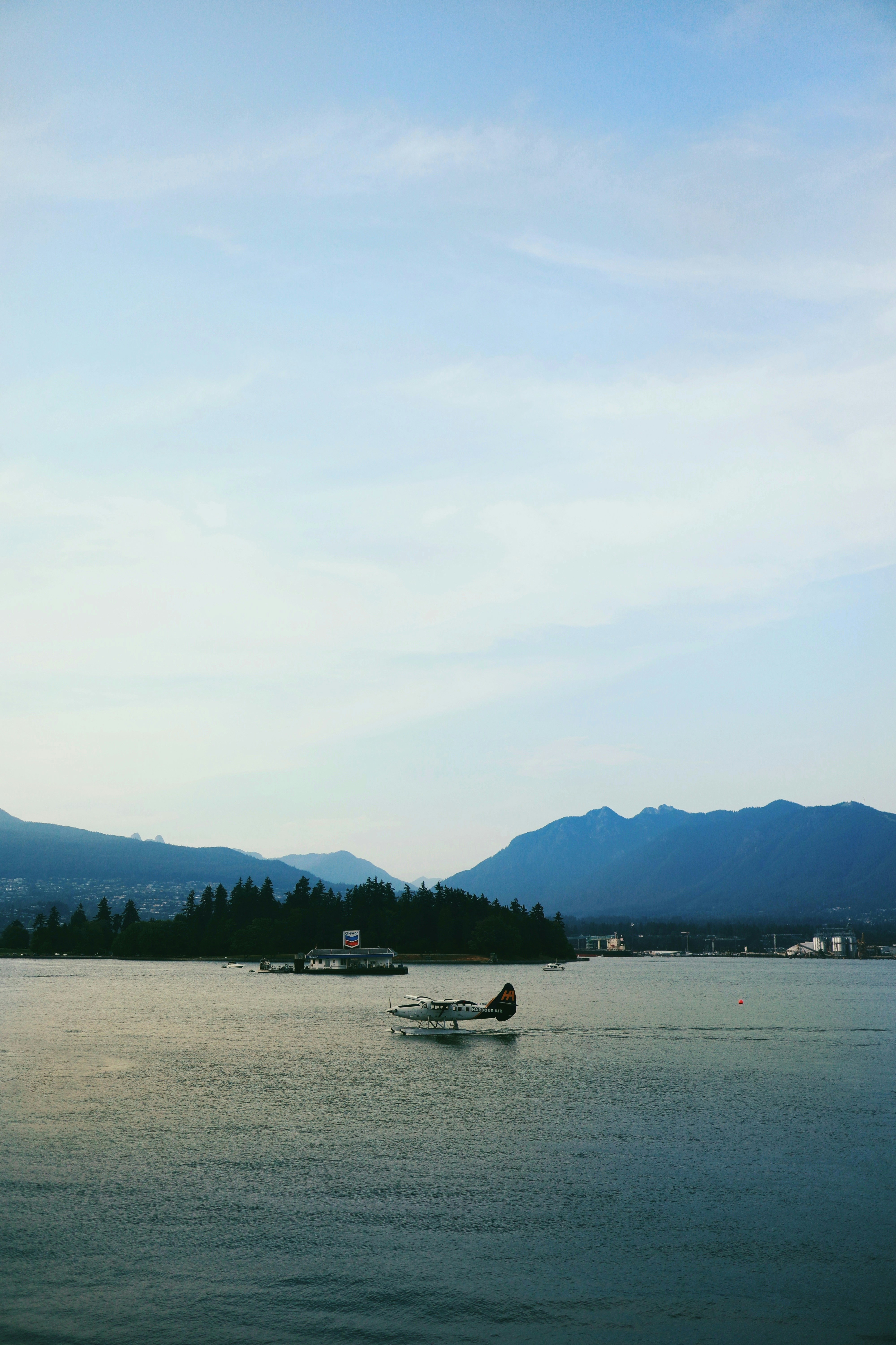 white boat on water near green mountain during daytime