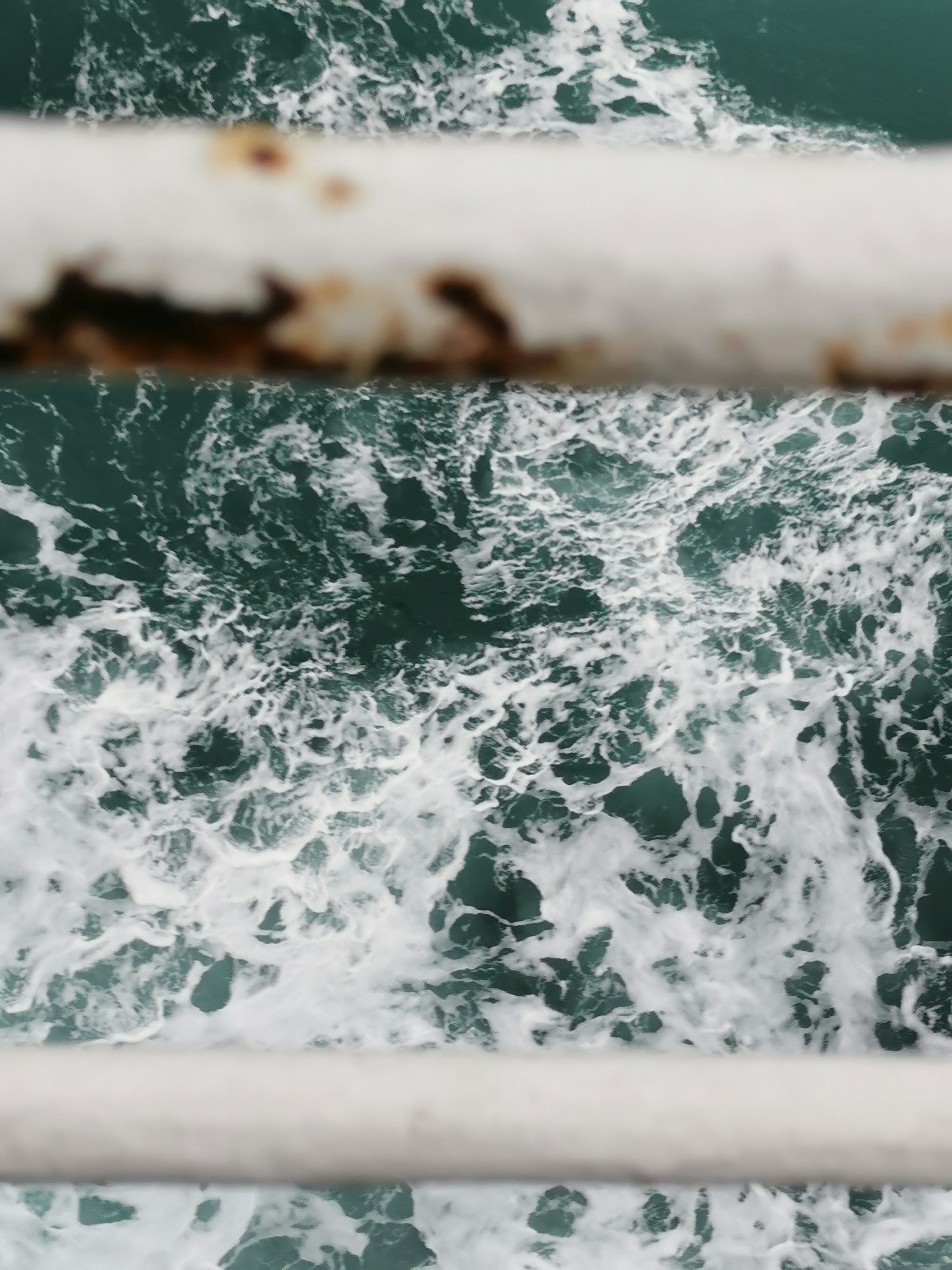 Rusted Rails, Turquoise Whirl: A Narrow View into Sea Foam