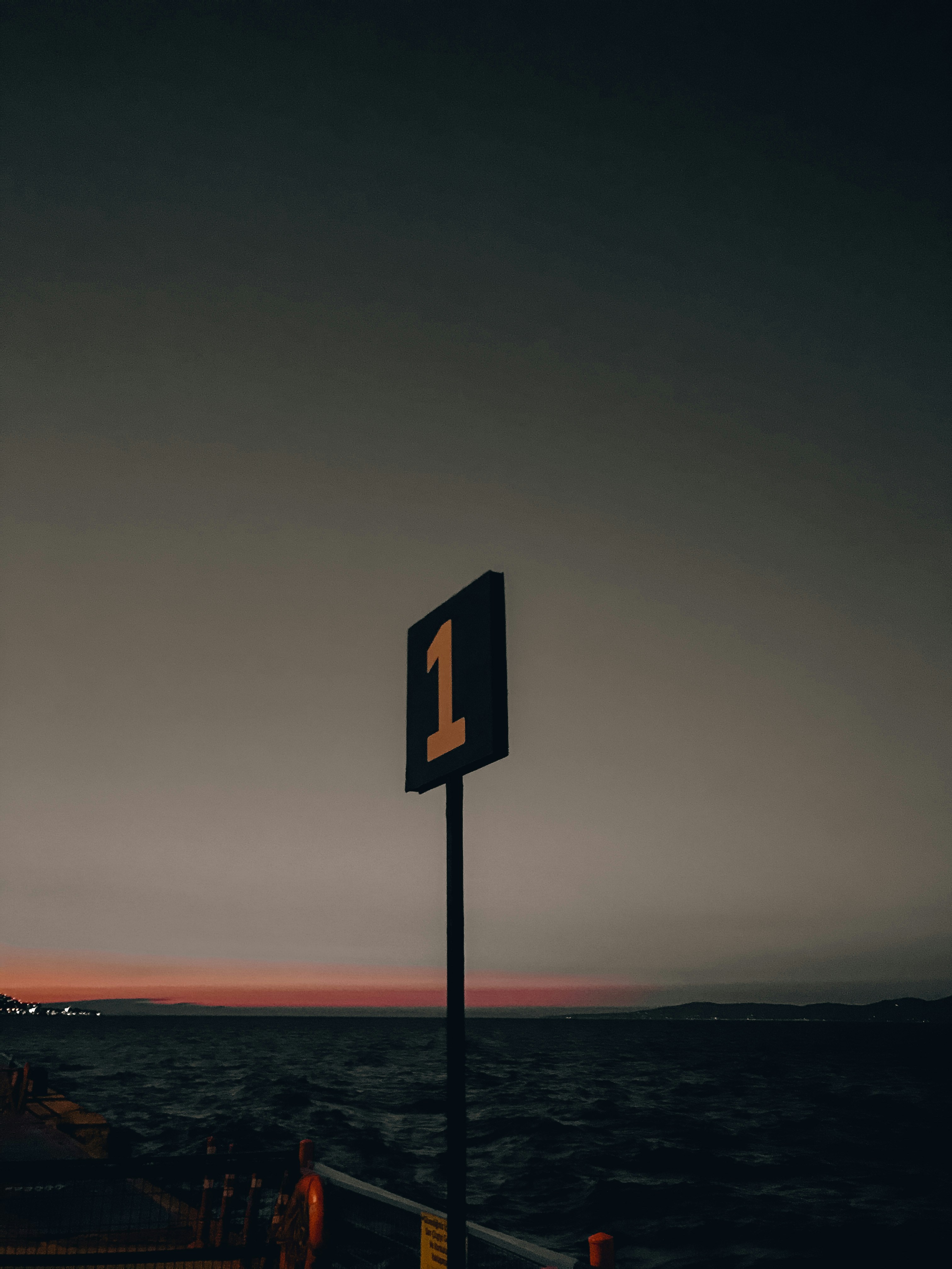 Silhouette Sign at Dusk over Quiet Waters