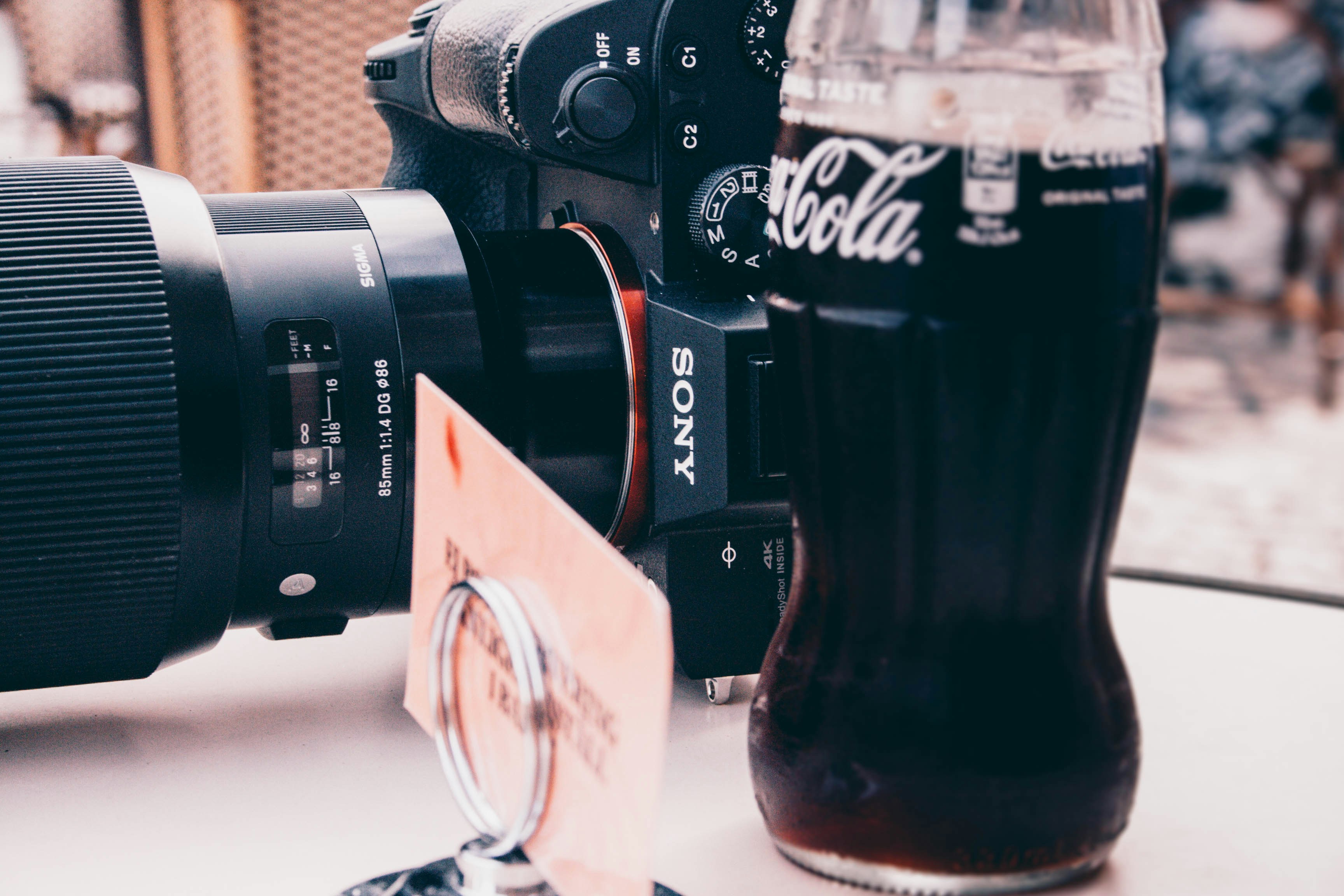 Focused Pause: A Lens, Coca-Cola, and a Quiet Studio Moment