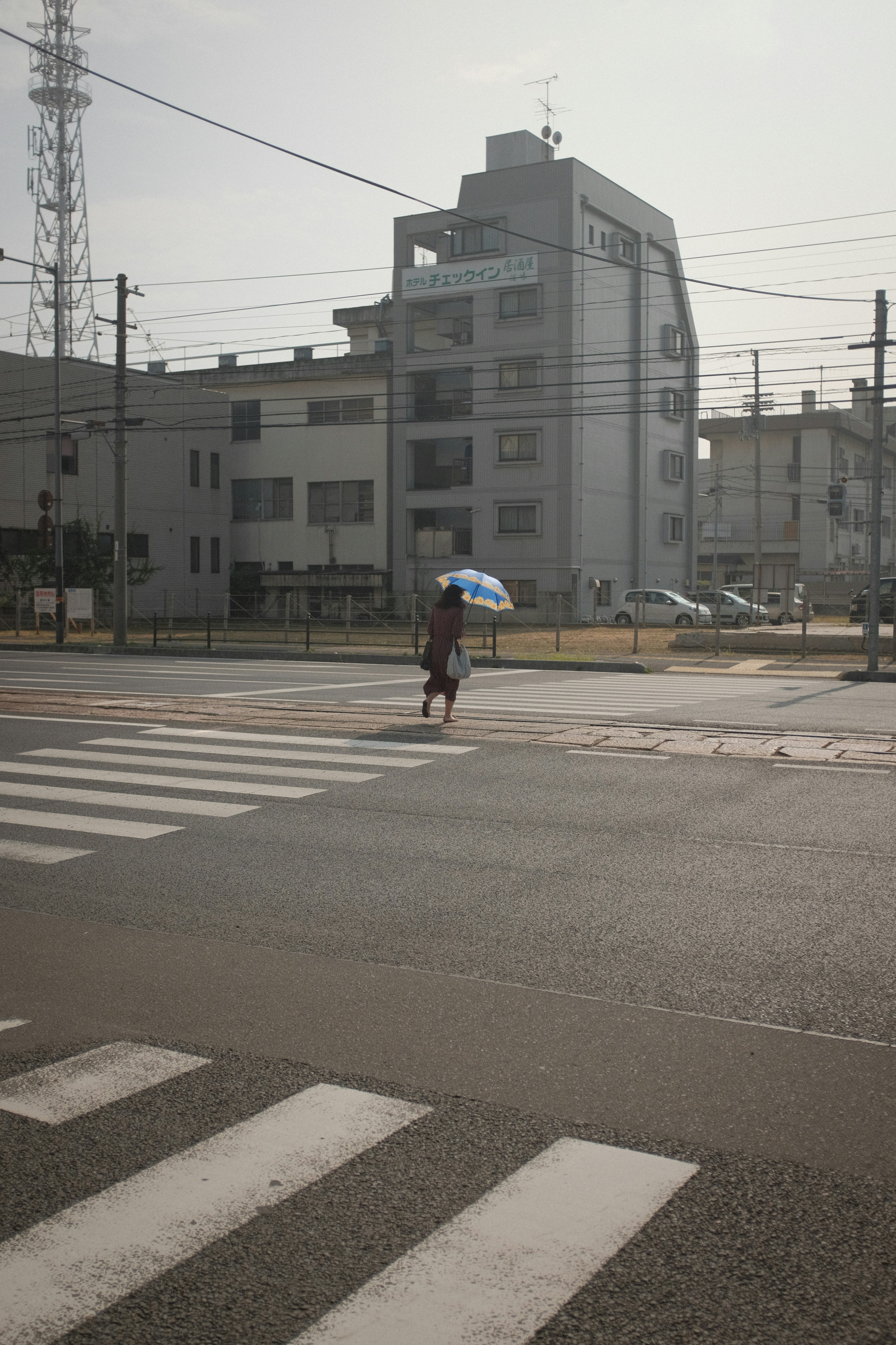 Blue Umbrella Crossing: A Quiet City Moment at the Crosswalk