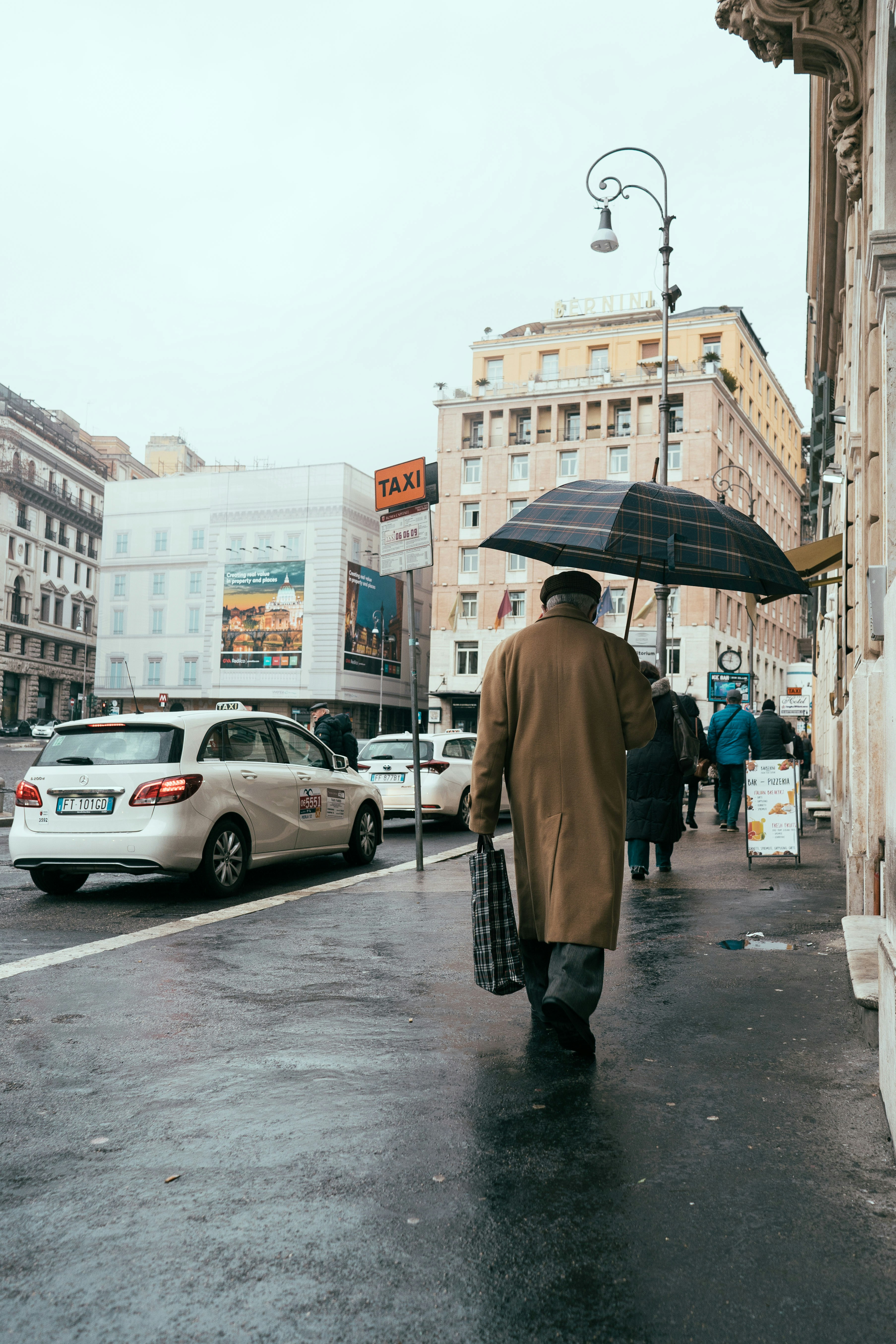 Man with umbrella. Rome, Italy