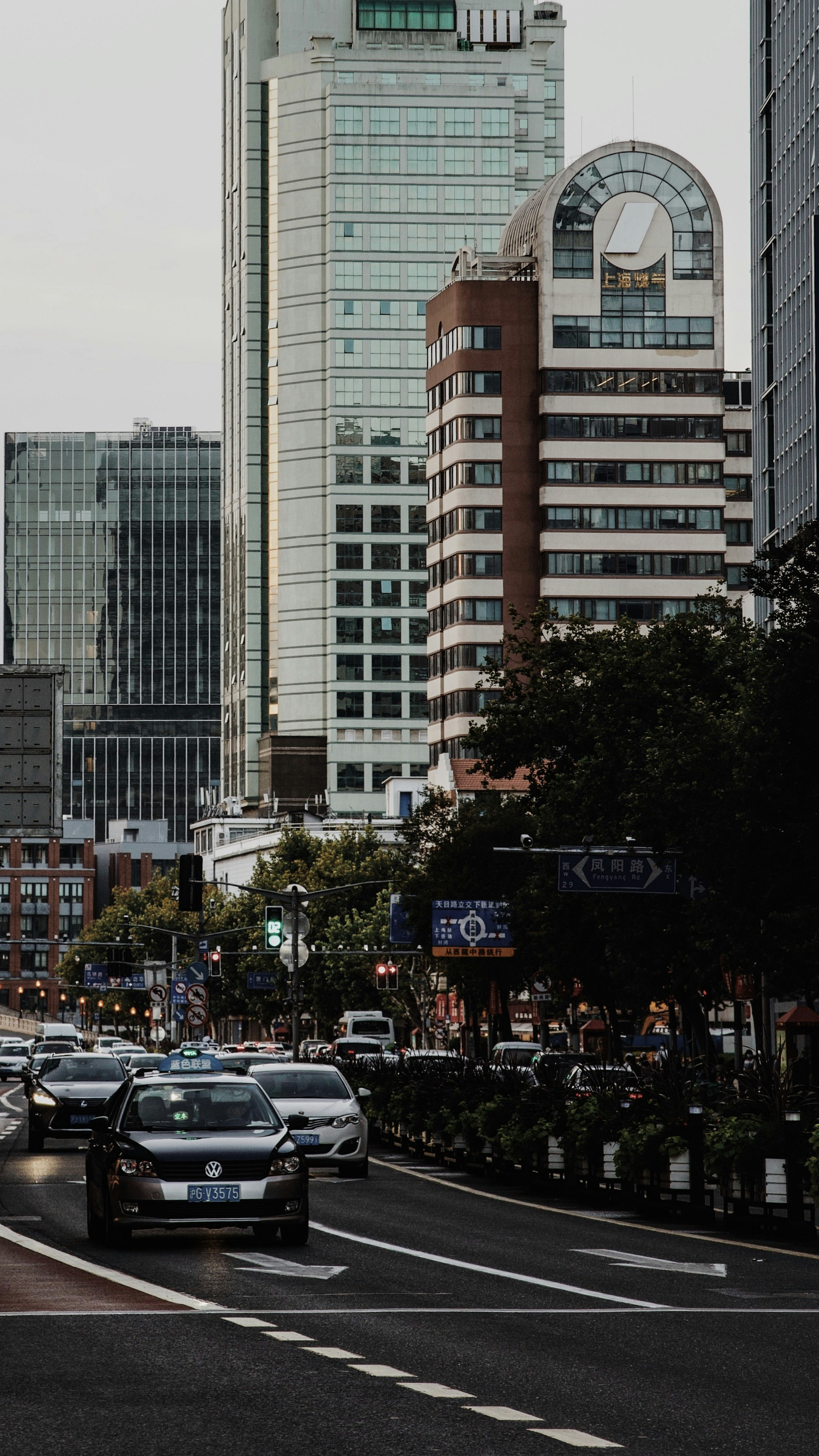 Cars parked on parking lot near high rise building during daytime photo ...
