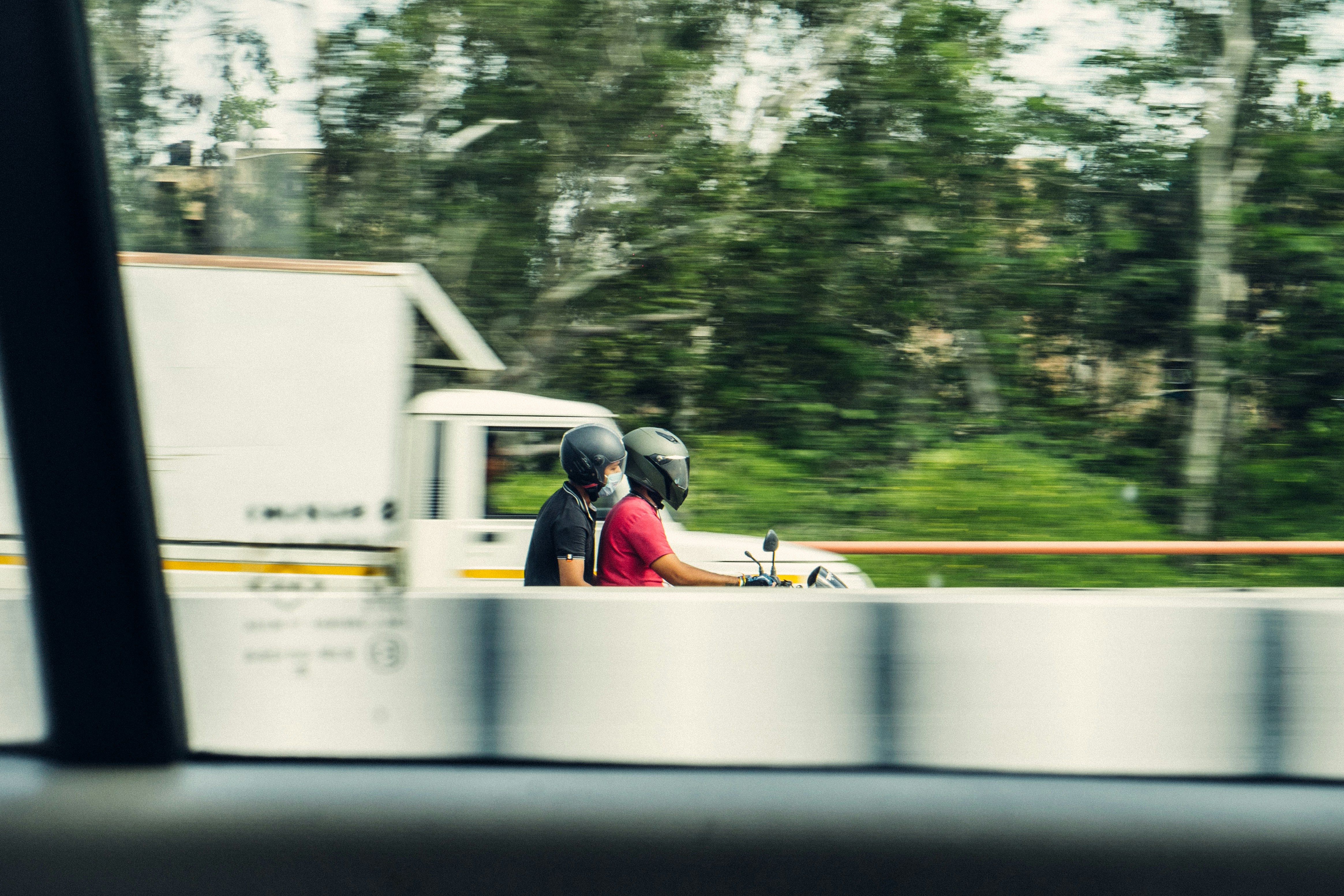 Two Riders in Motion: A Window-Frame Highway Moment