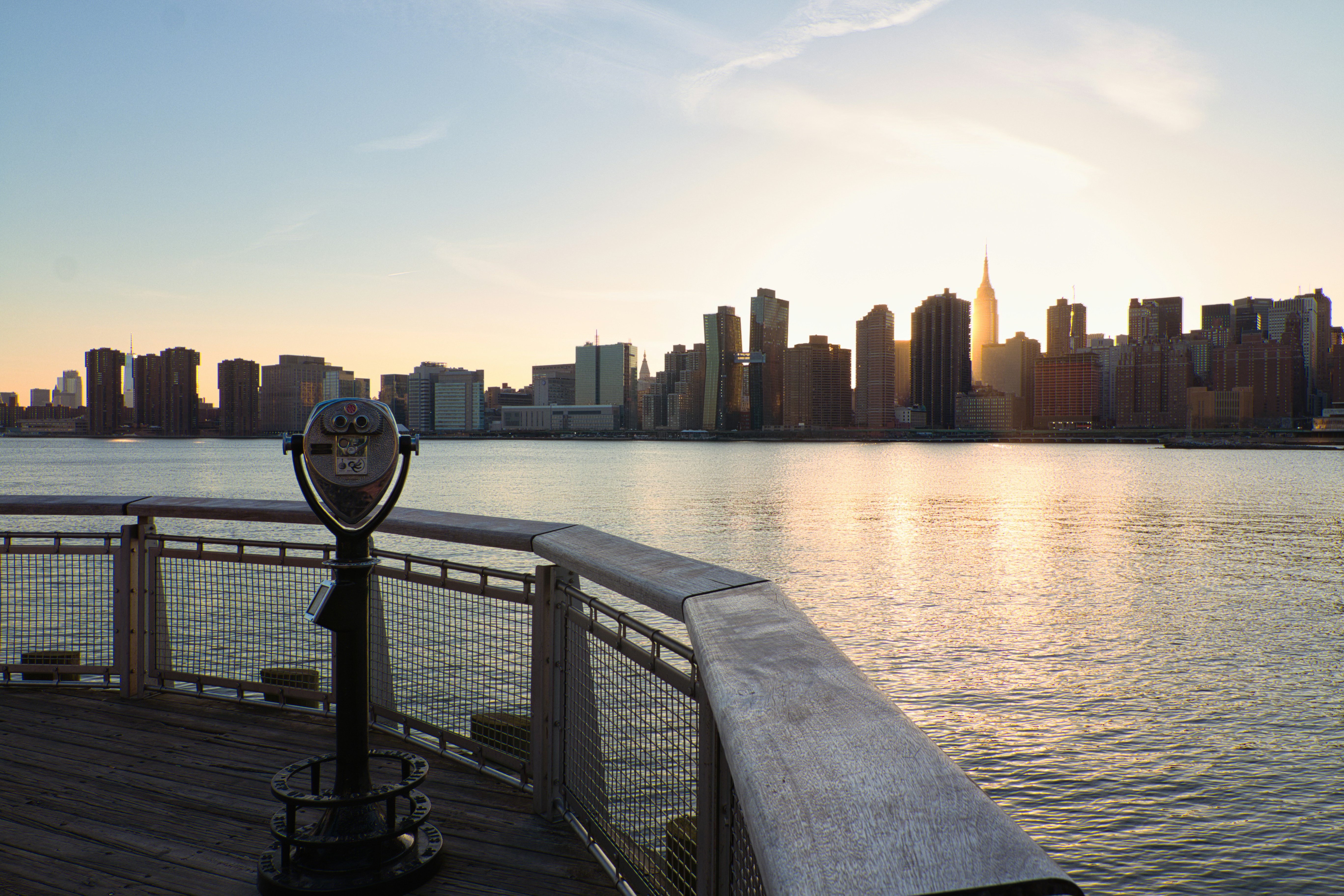 black and gray telescope on gray wooden dock during daytime