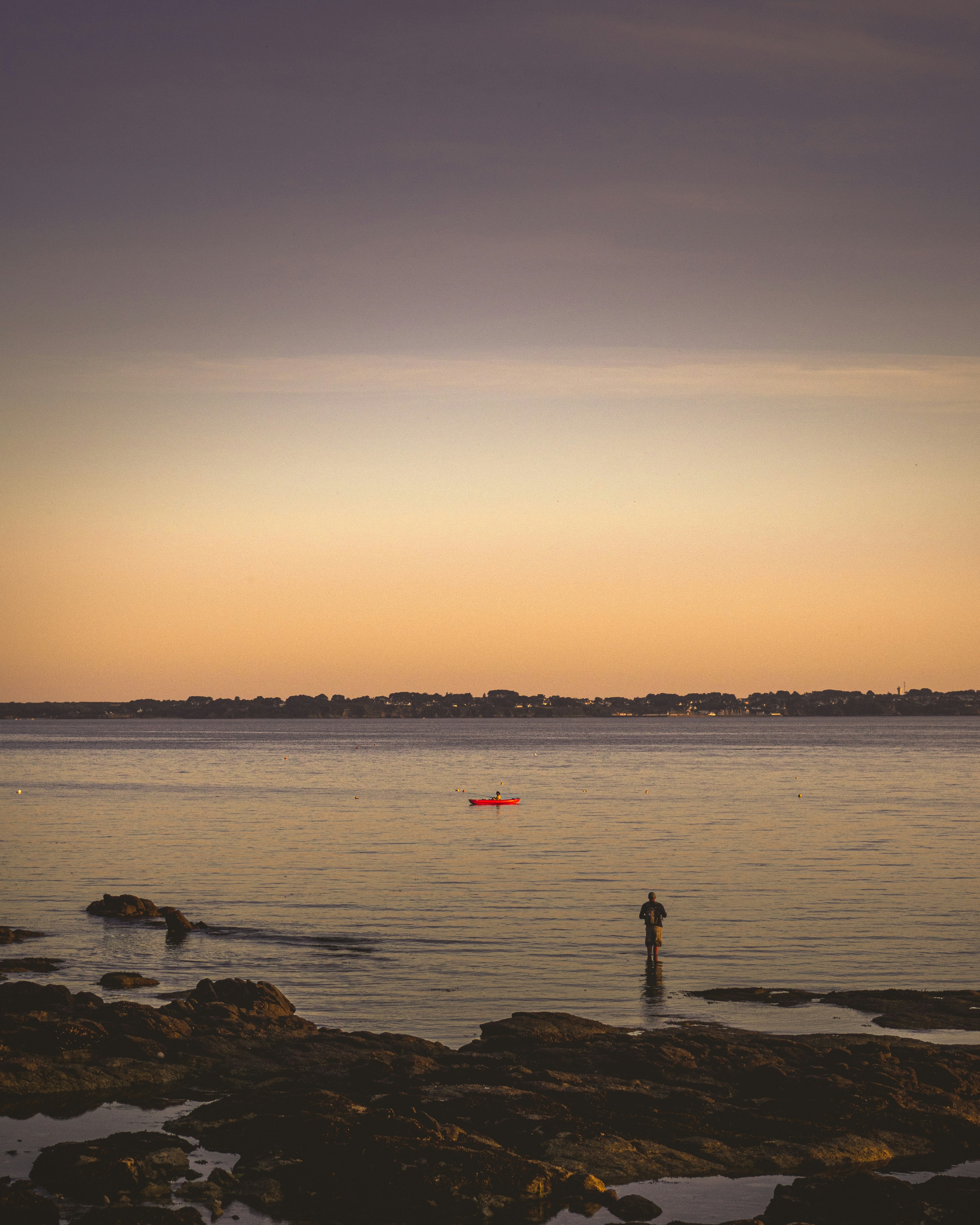 Crimson Boat at Dusk: A solitary figure anchors the horizon