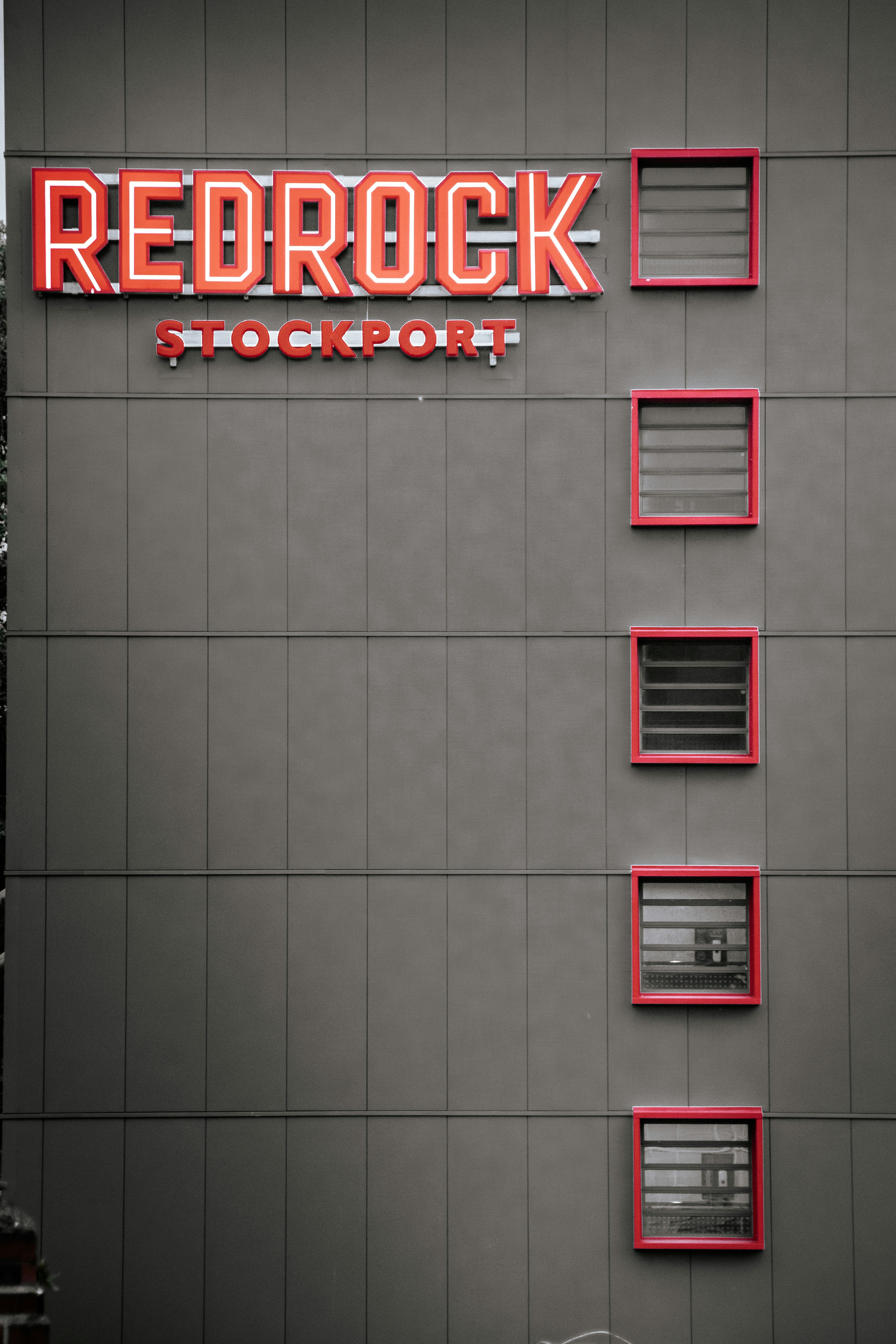 A building with a red brick sign on the side of it photo – Free ...