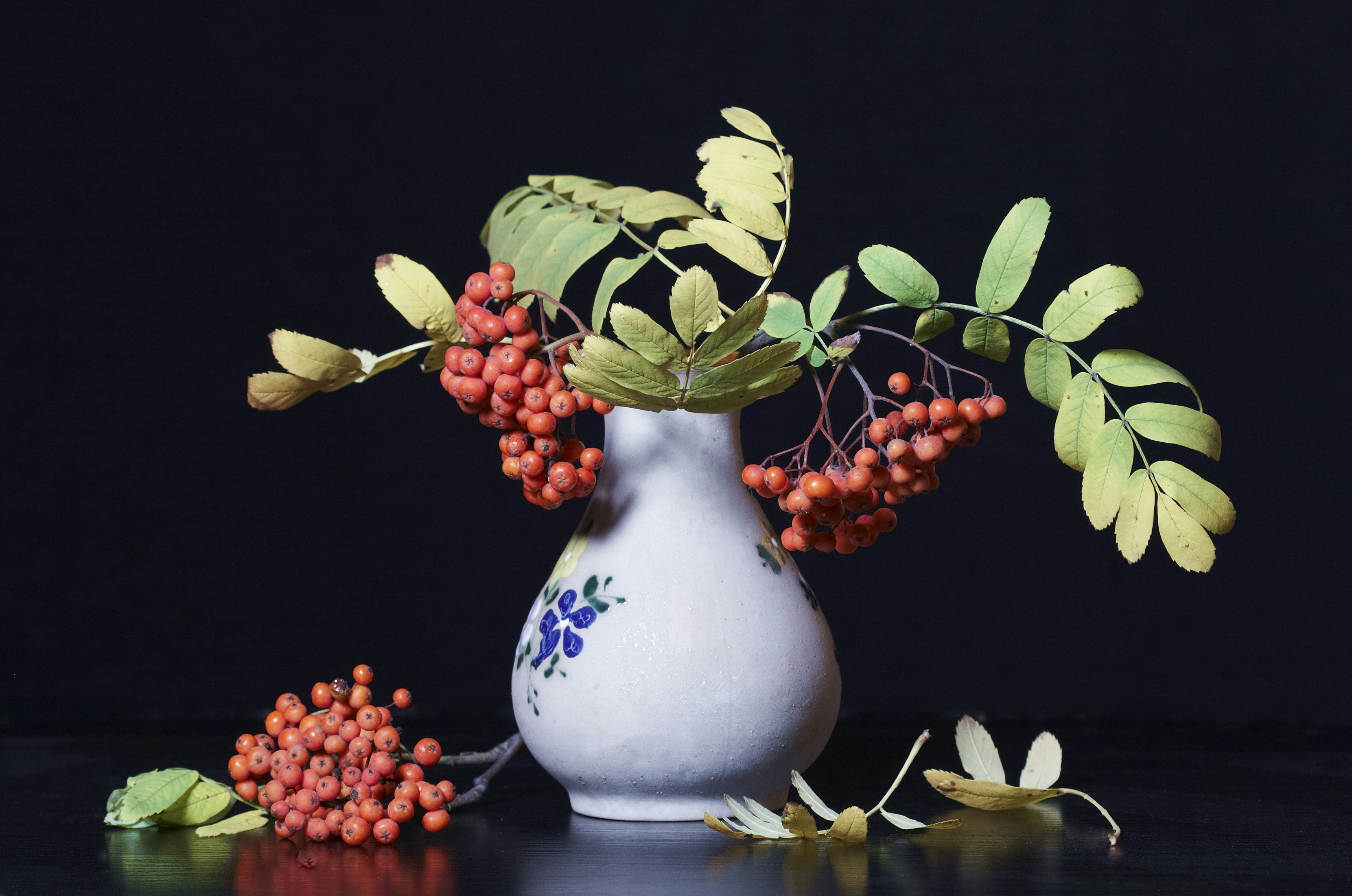 Crimson Berries Framing a Moonlit Porcelain Vase