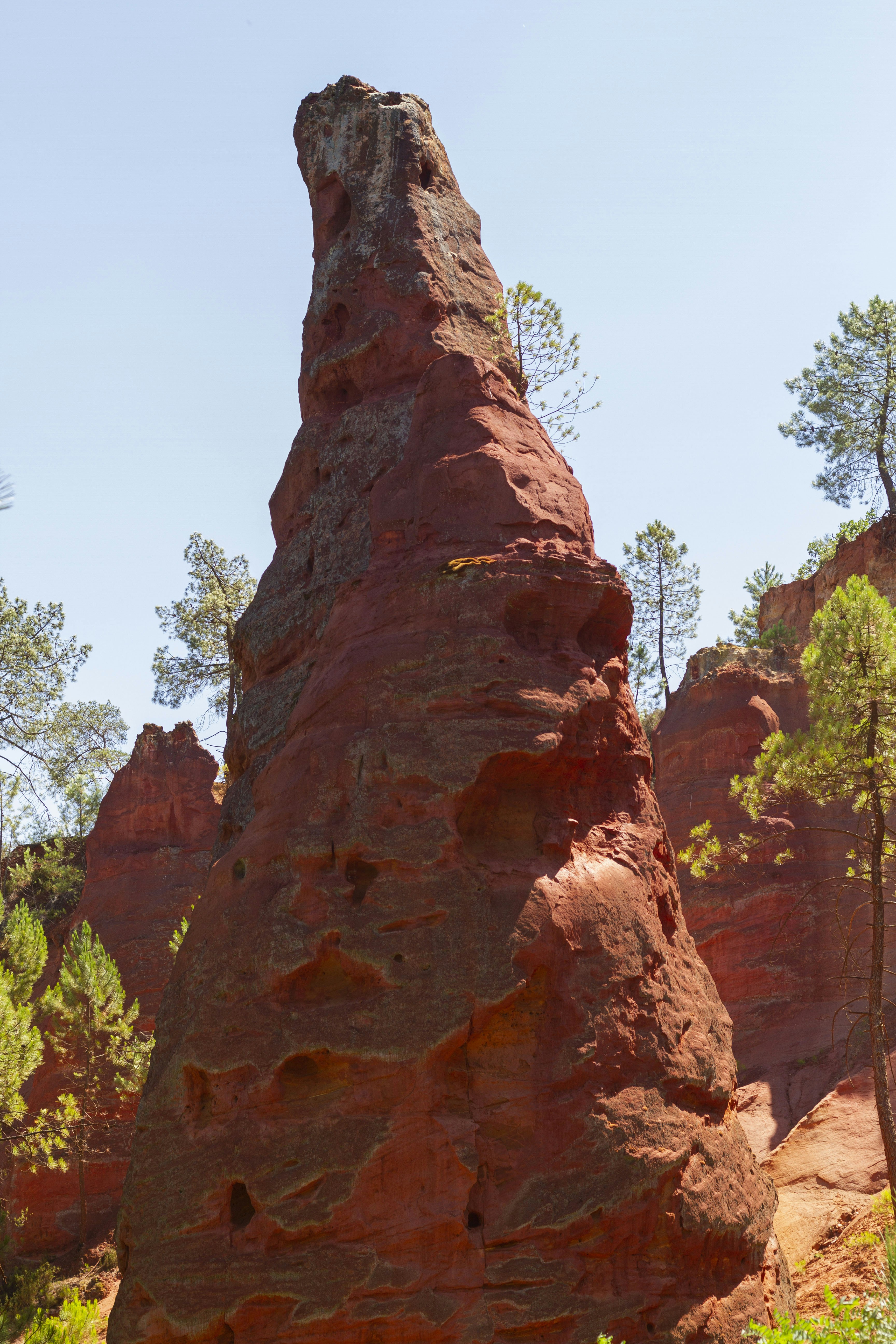 Red Needle Tower Reaching Toward a Clear Sky
