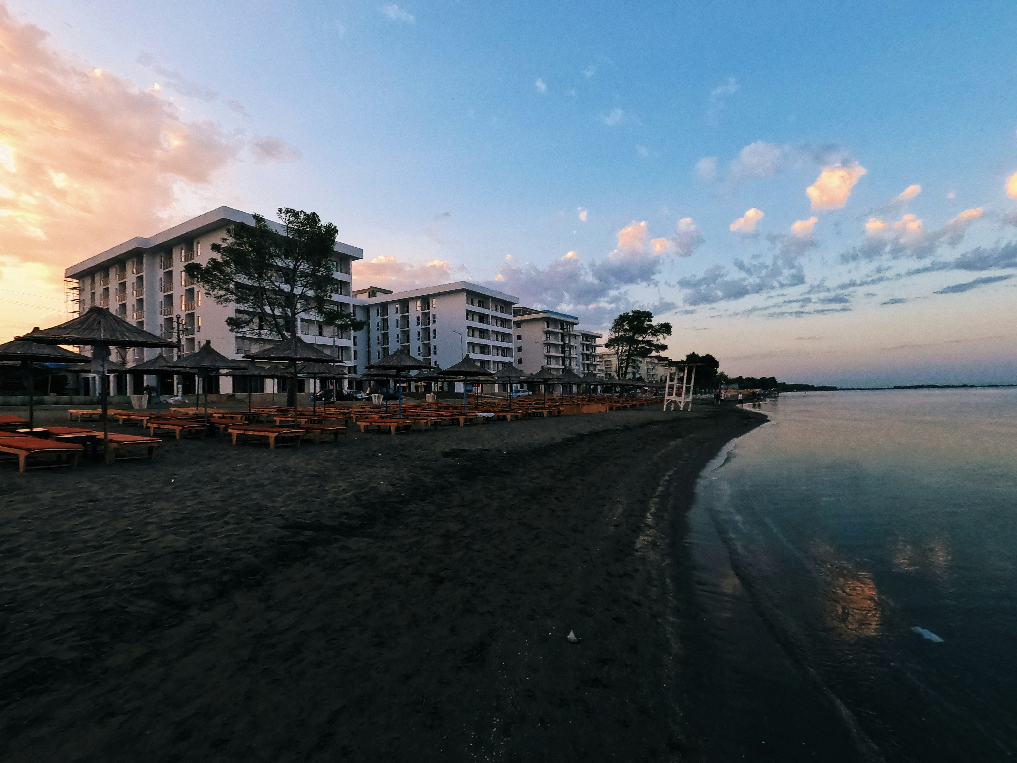 5AM morning in Shengjin, Albania Beach. | white and brown concrete building near body of water during daytime