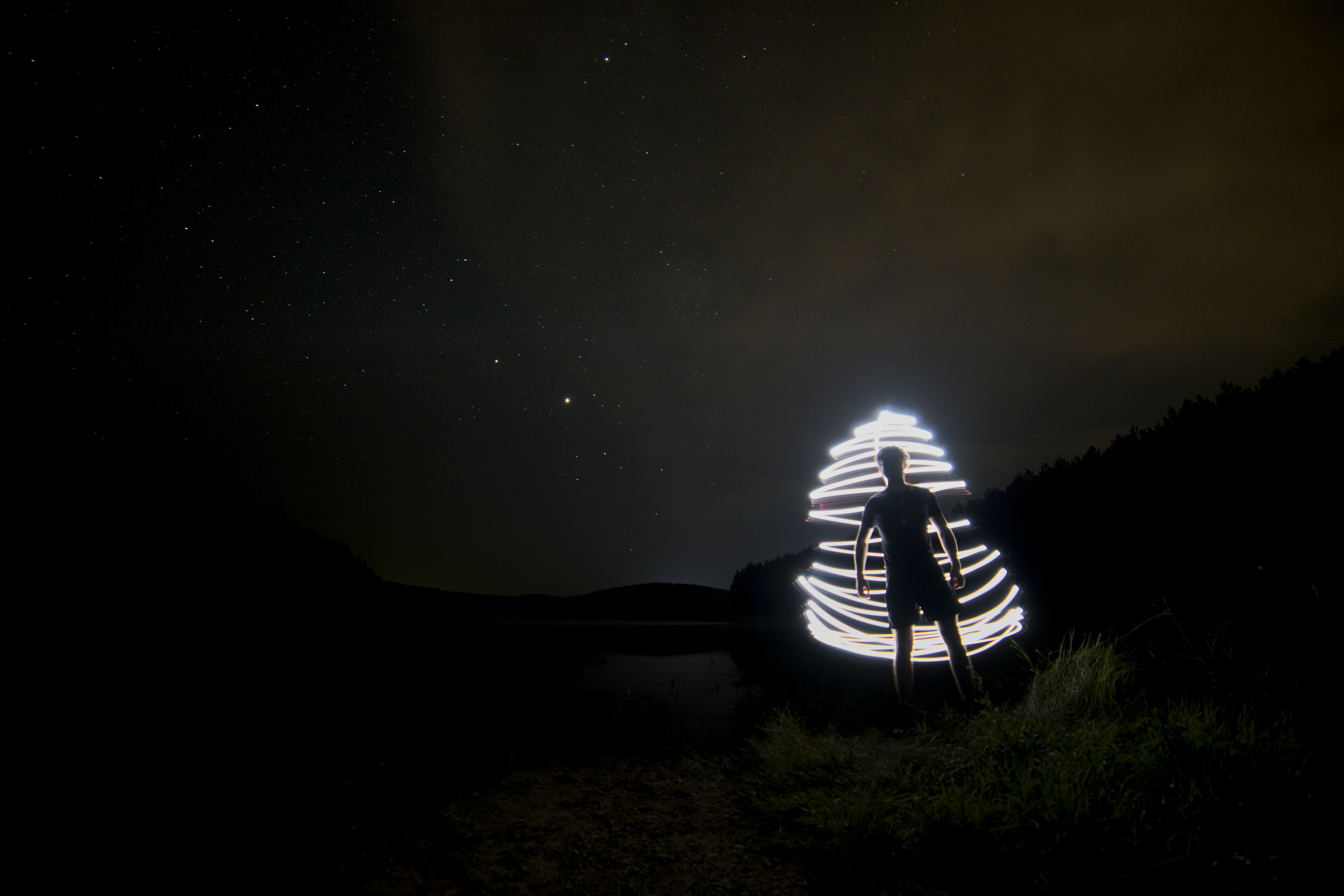 Spiral Light Portrait by the Shore Under a Quiet Starfield