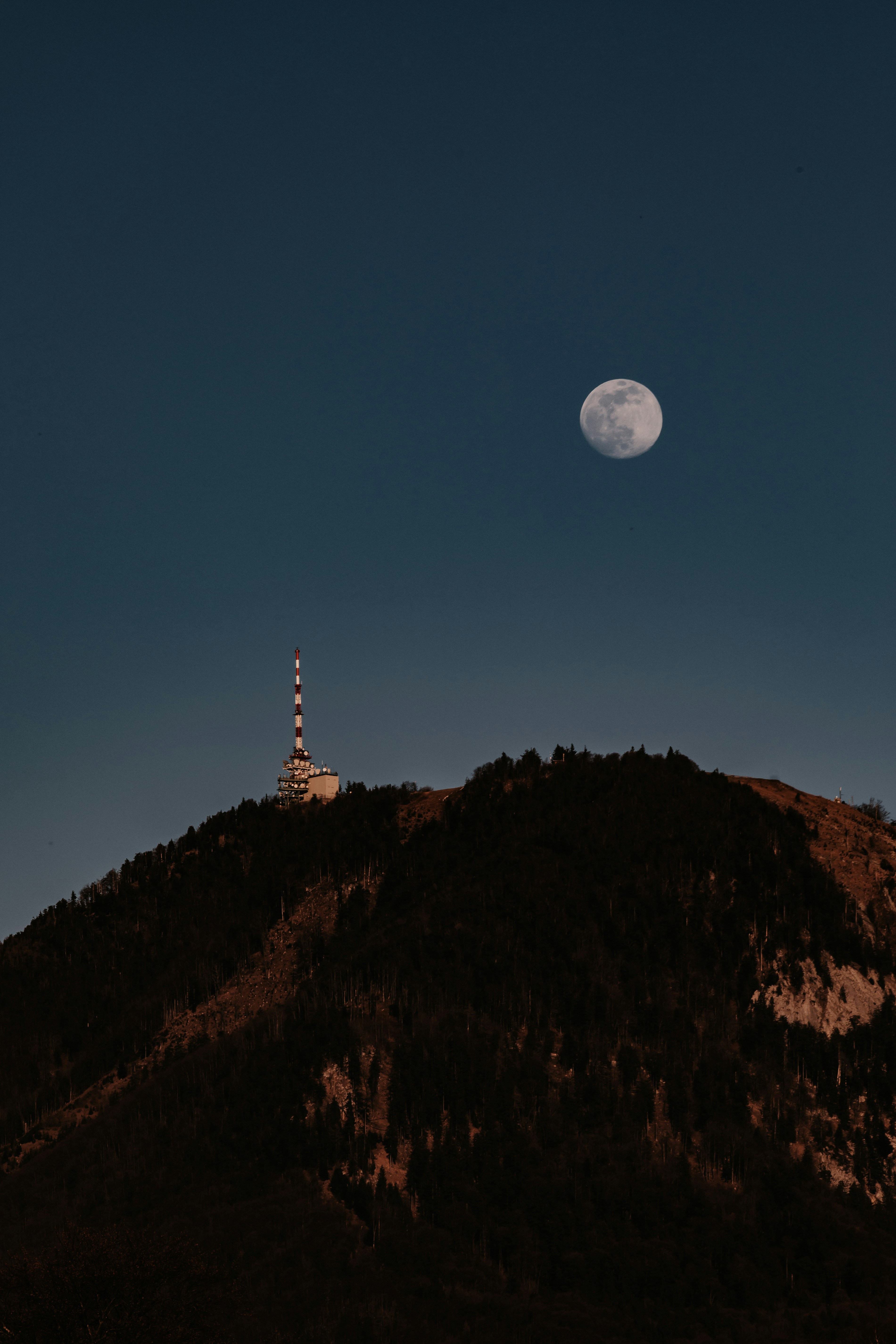 Moon Above the Ridge: A Night Scene with a Tower Silhouette