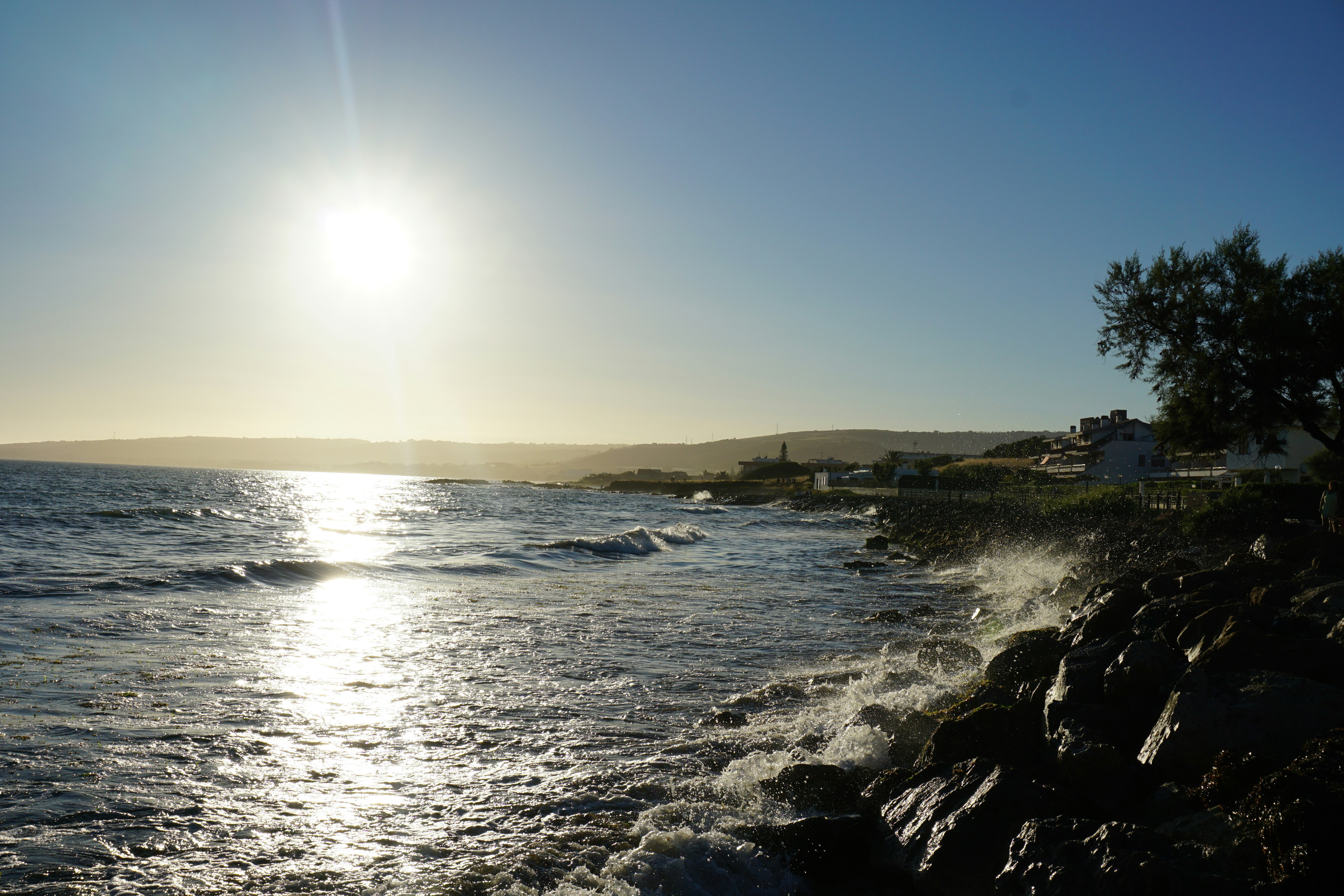 Sunlit Serenity by the Rocky Shore